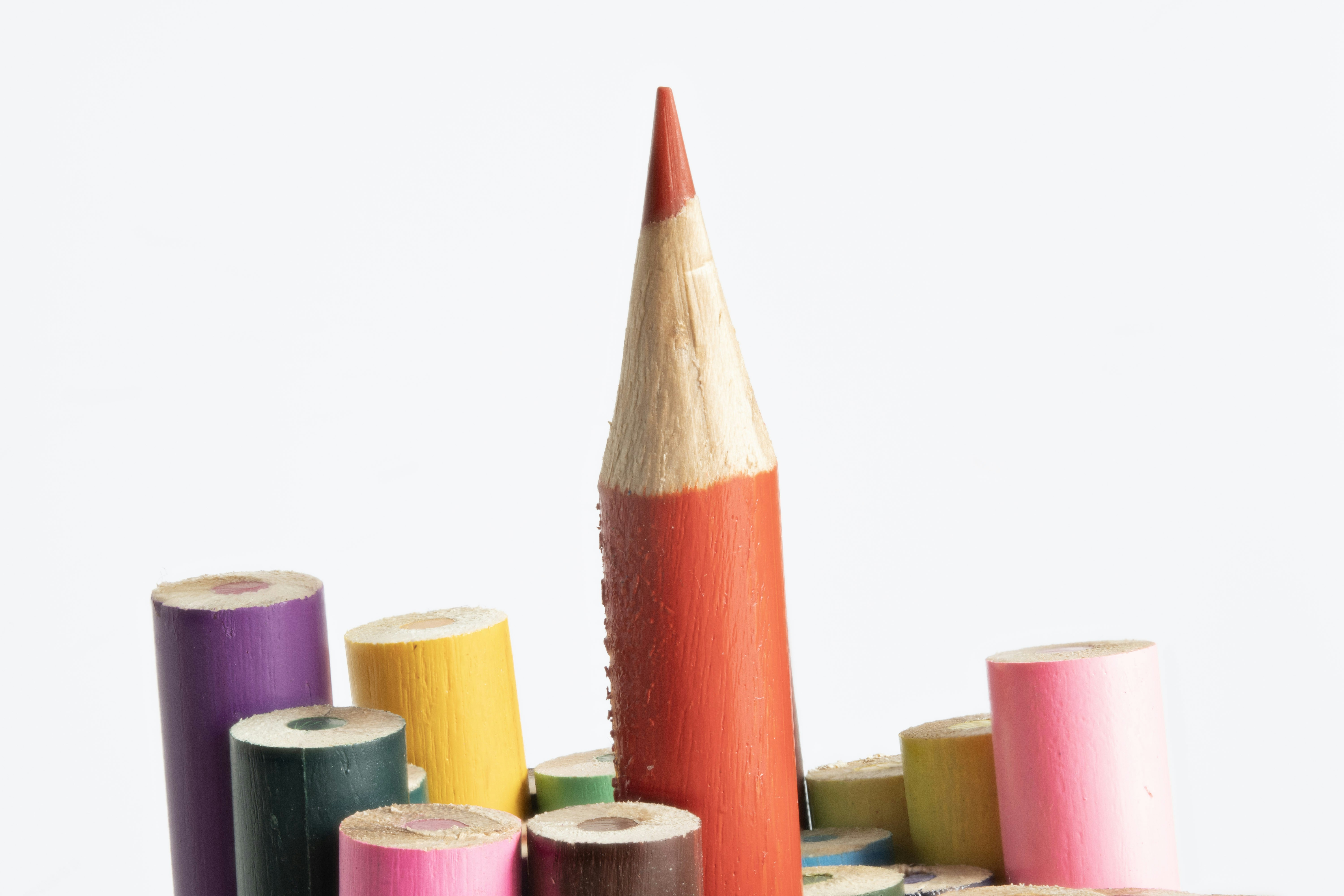 Crayon Crown: A Red Pencil Rising Among Coloured Stacks