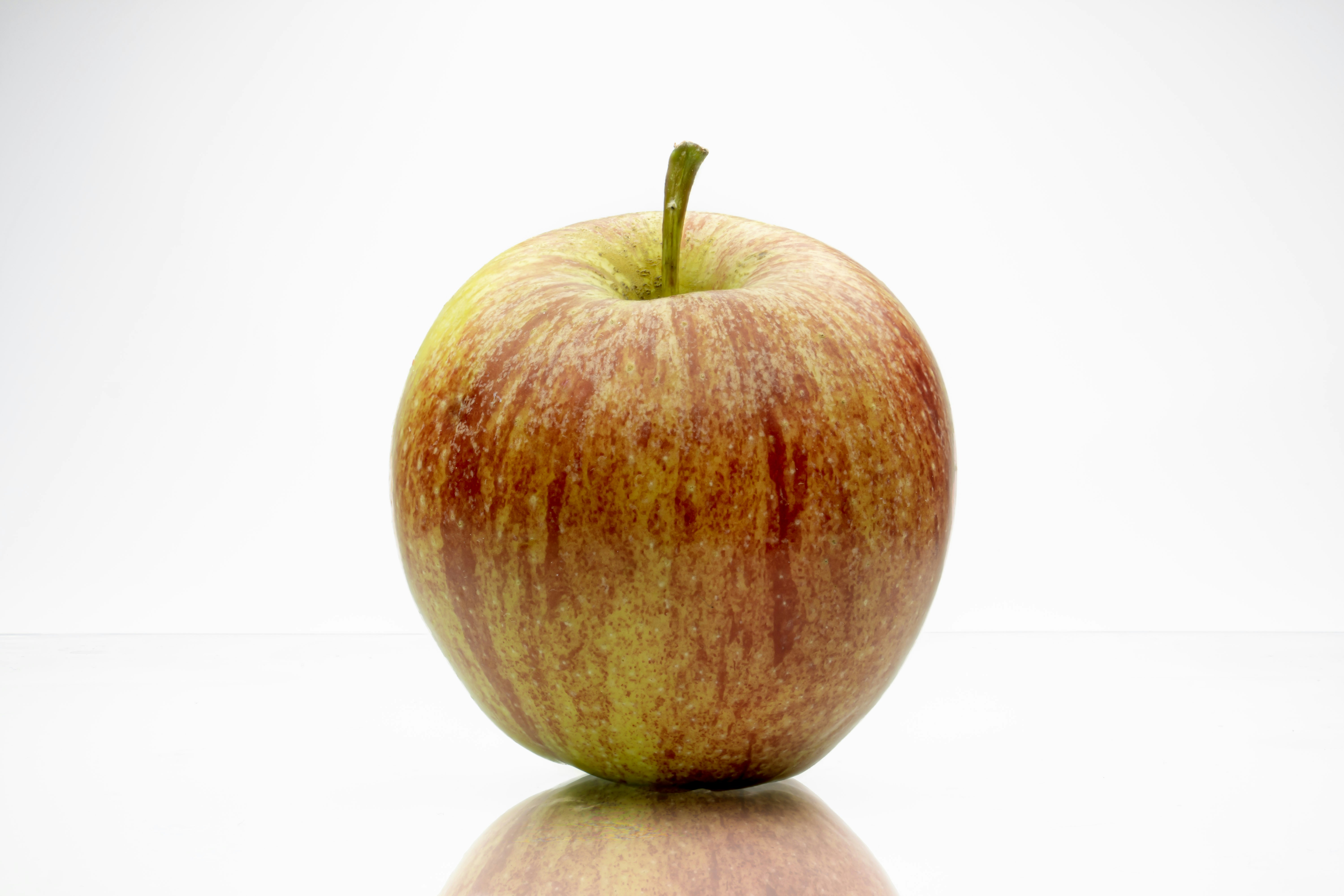 Red Apple on a Mirror: Minimal Portrait of Juicy Simplicity