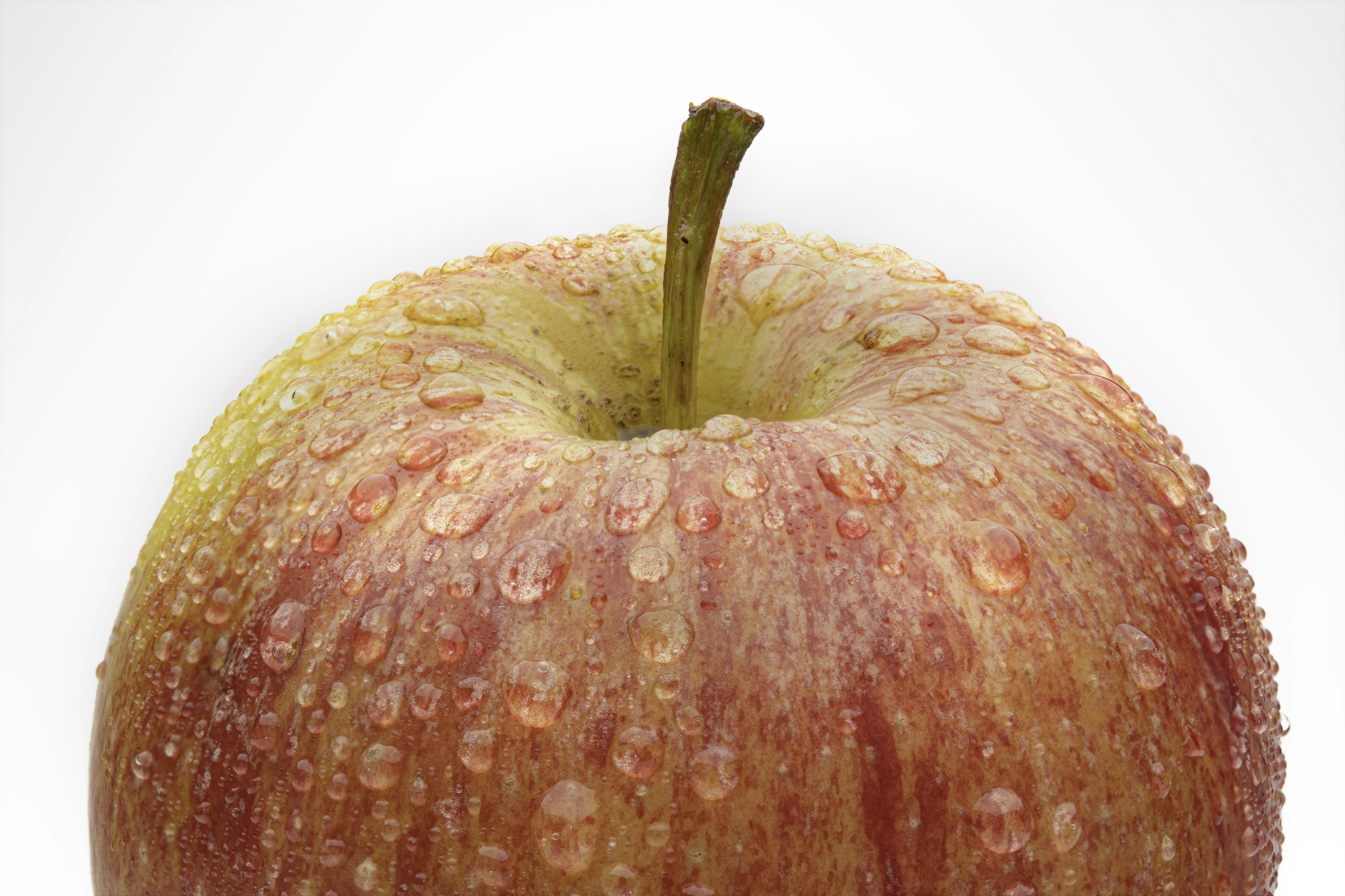 Dew-Kissed Gala: A Close-Up of a Fresh Apple Crowned with Droplets