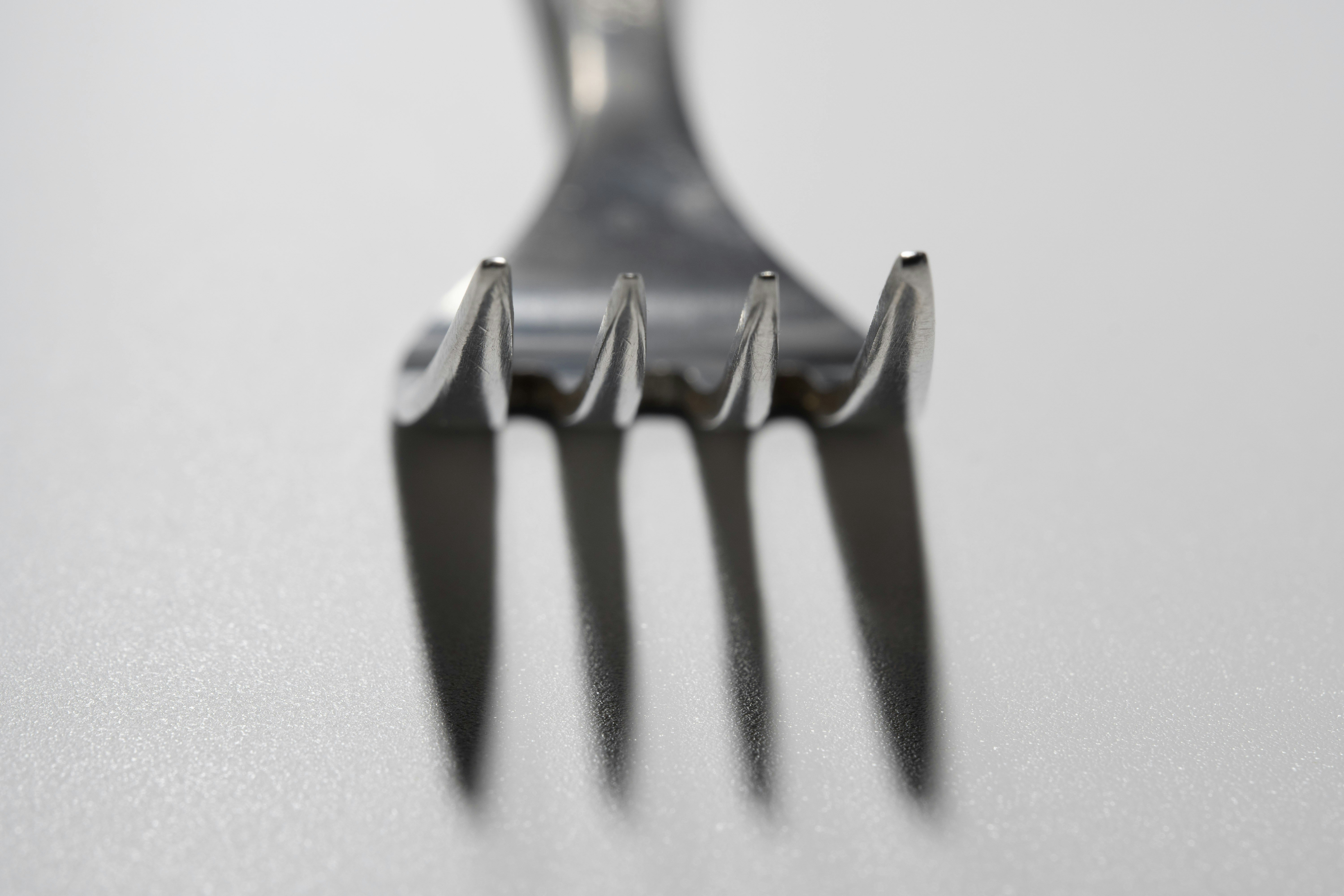 Close-Up of a Fork's Tines: Shallow Depth of Field on a Metallic Surface