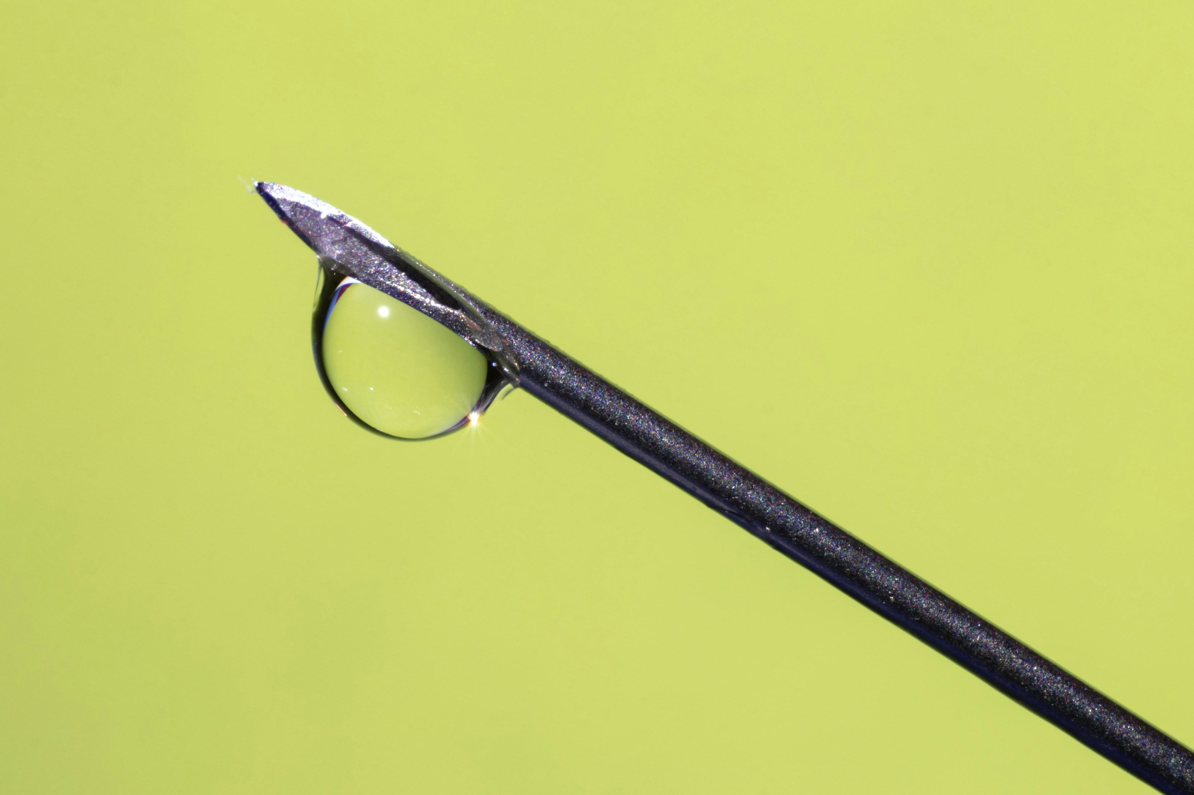 A Droplet Clings to the Nib: Macro Moment on a Needle Tip