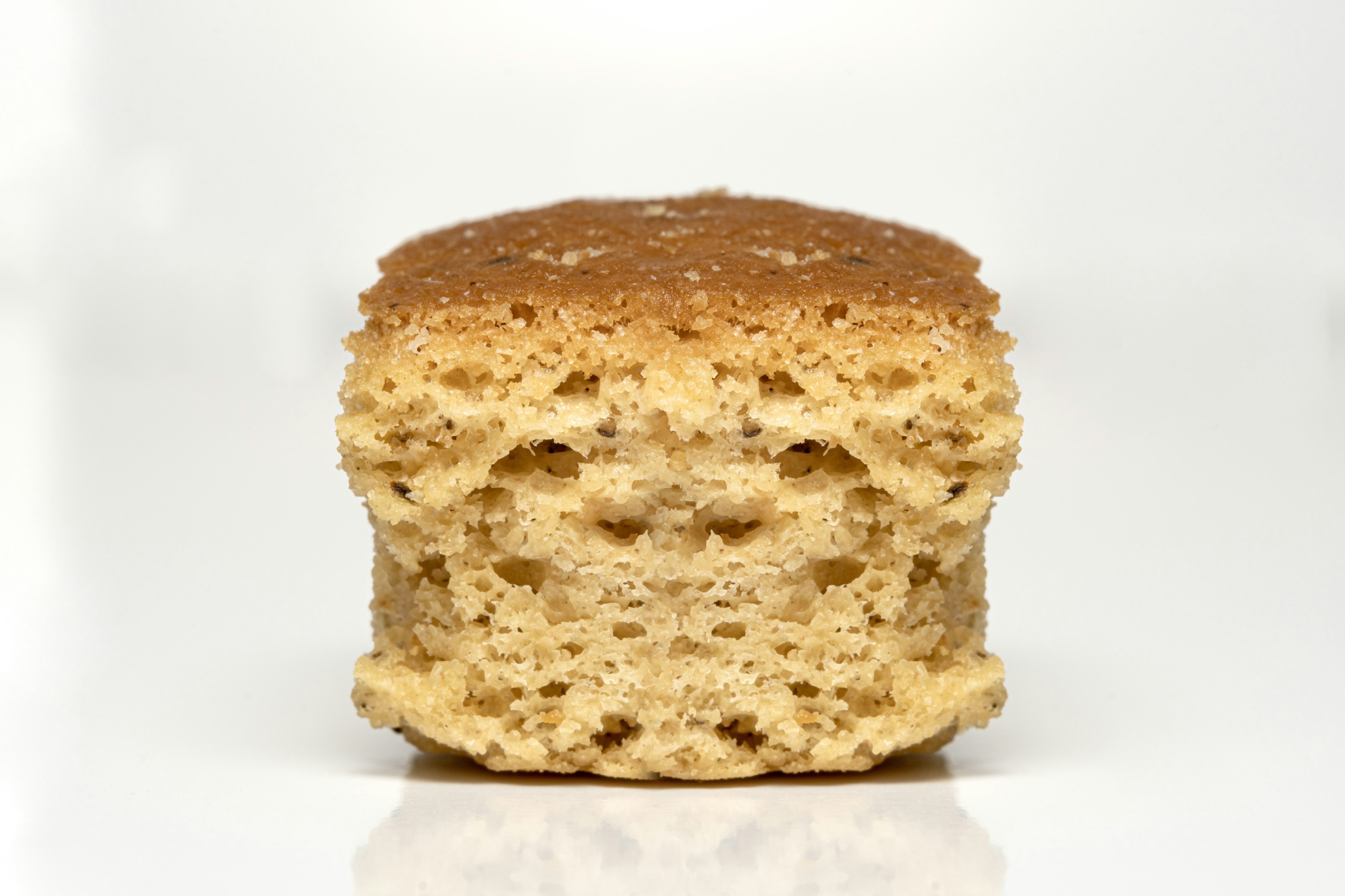 Tiny Castaway: A Golden Mini Sponge on a White Stage