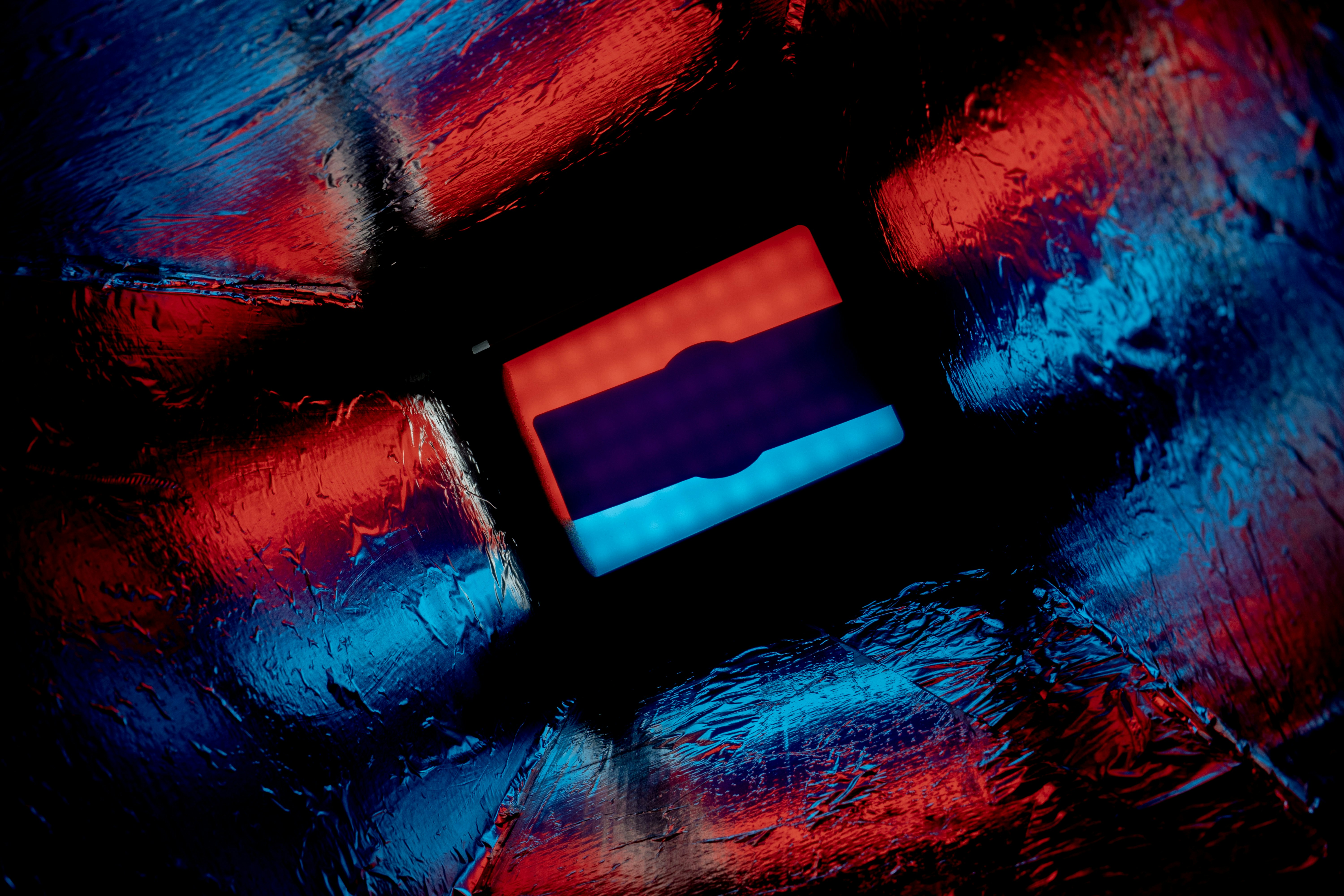 Neon Prism: A Glowing Chip Surrounded by Ice-Blue and Crimson Reflections