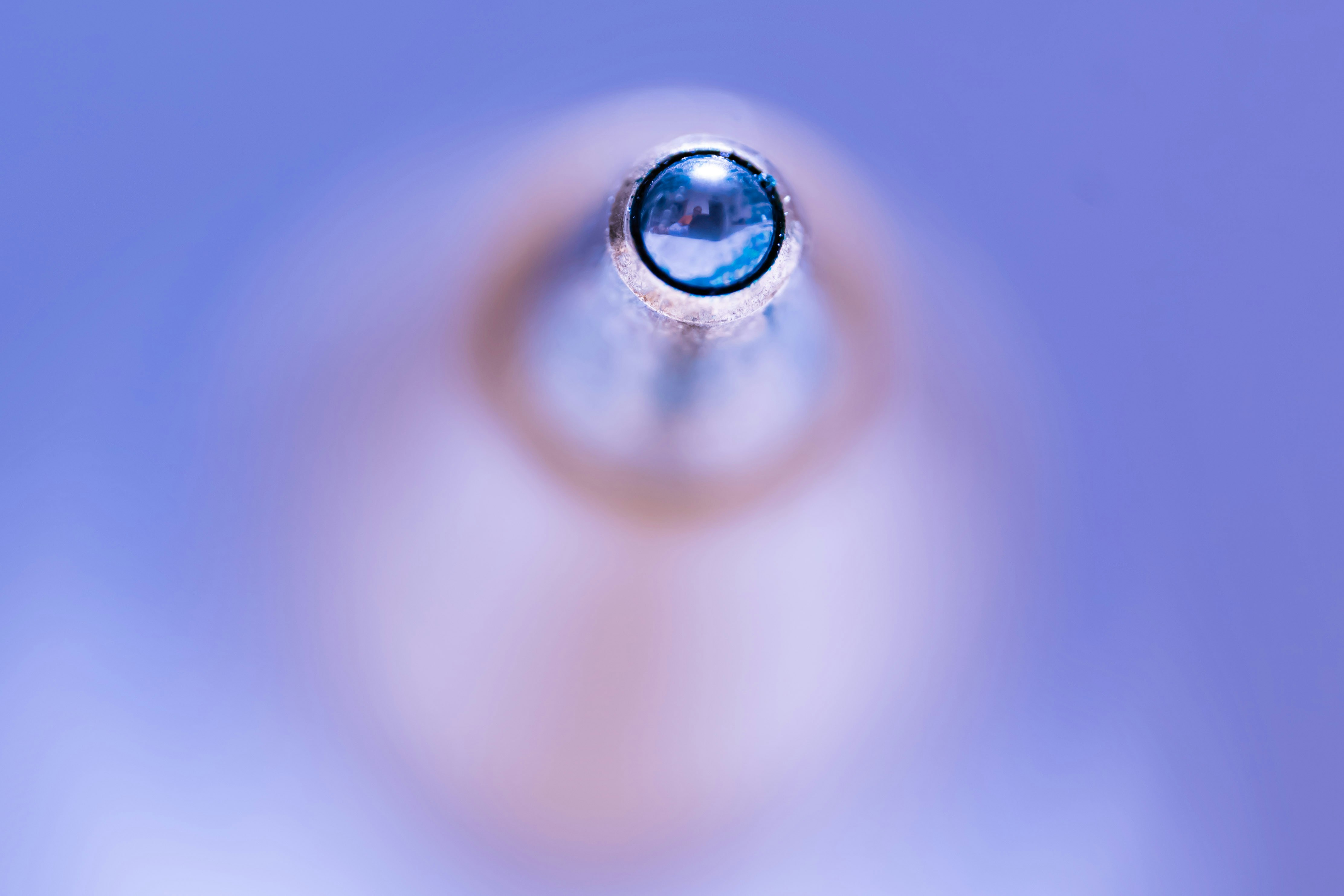 Macro Mirror: Tiny Blue Lens Within a Vignette