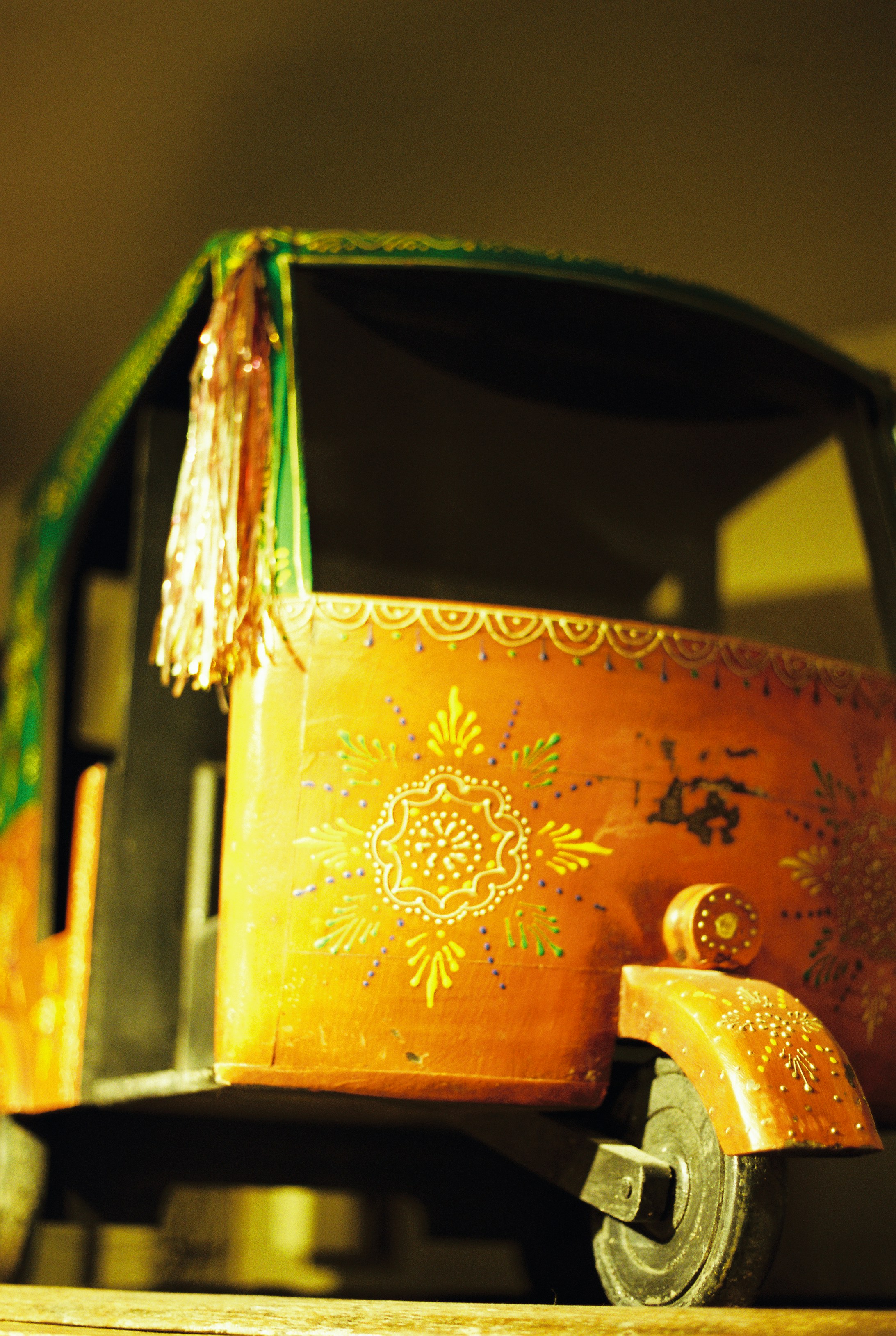 Amber Wagon: A Vintage Toy Car Under Dim Evening Light