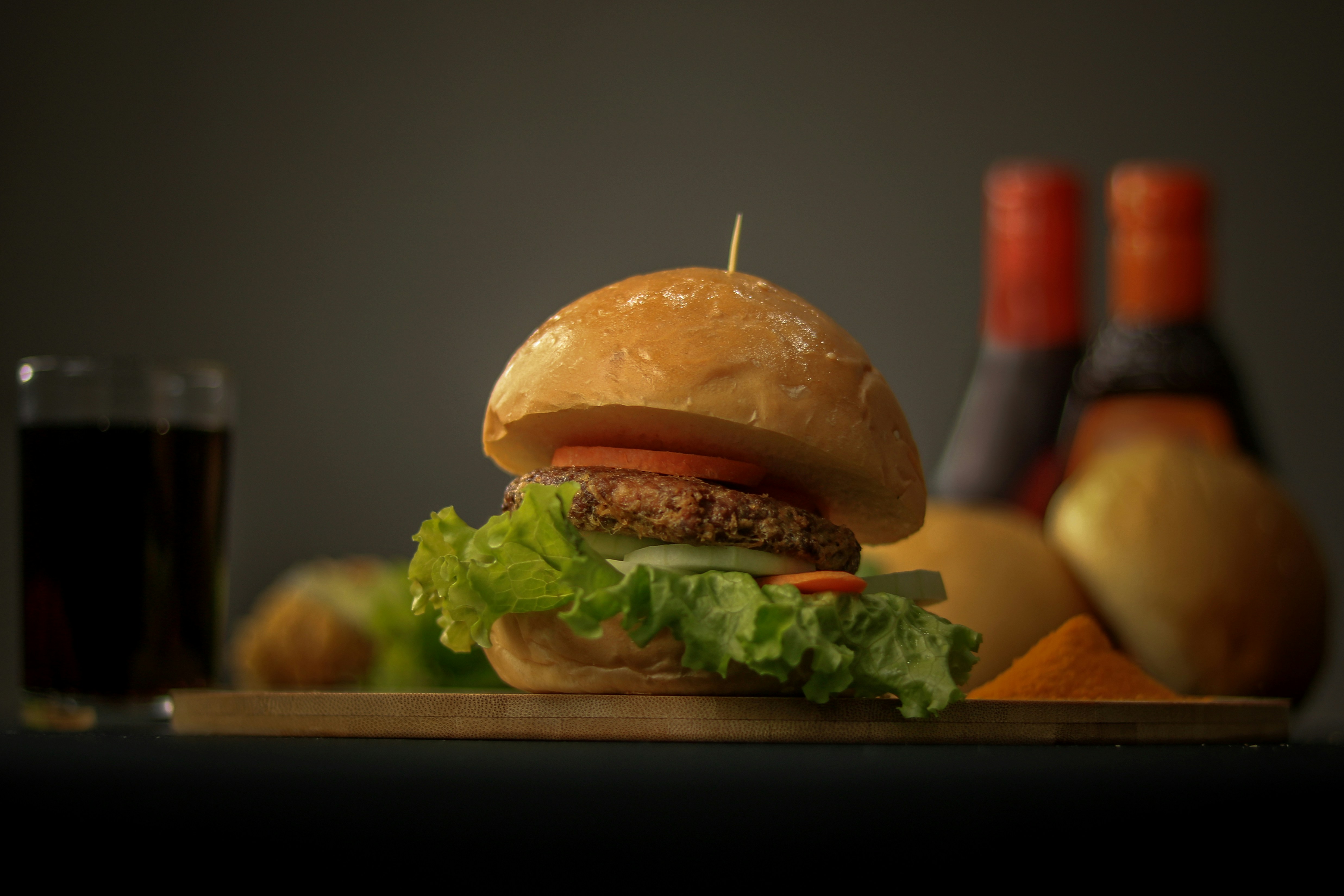 Juicy Burger Under Moody Bar Lighting