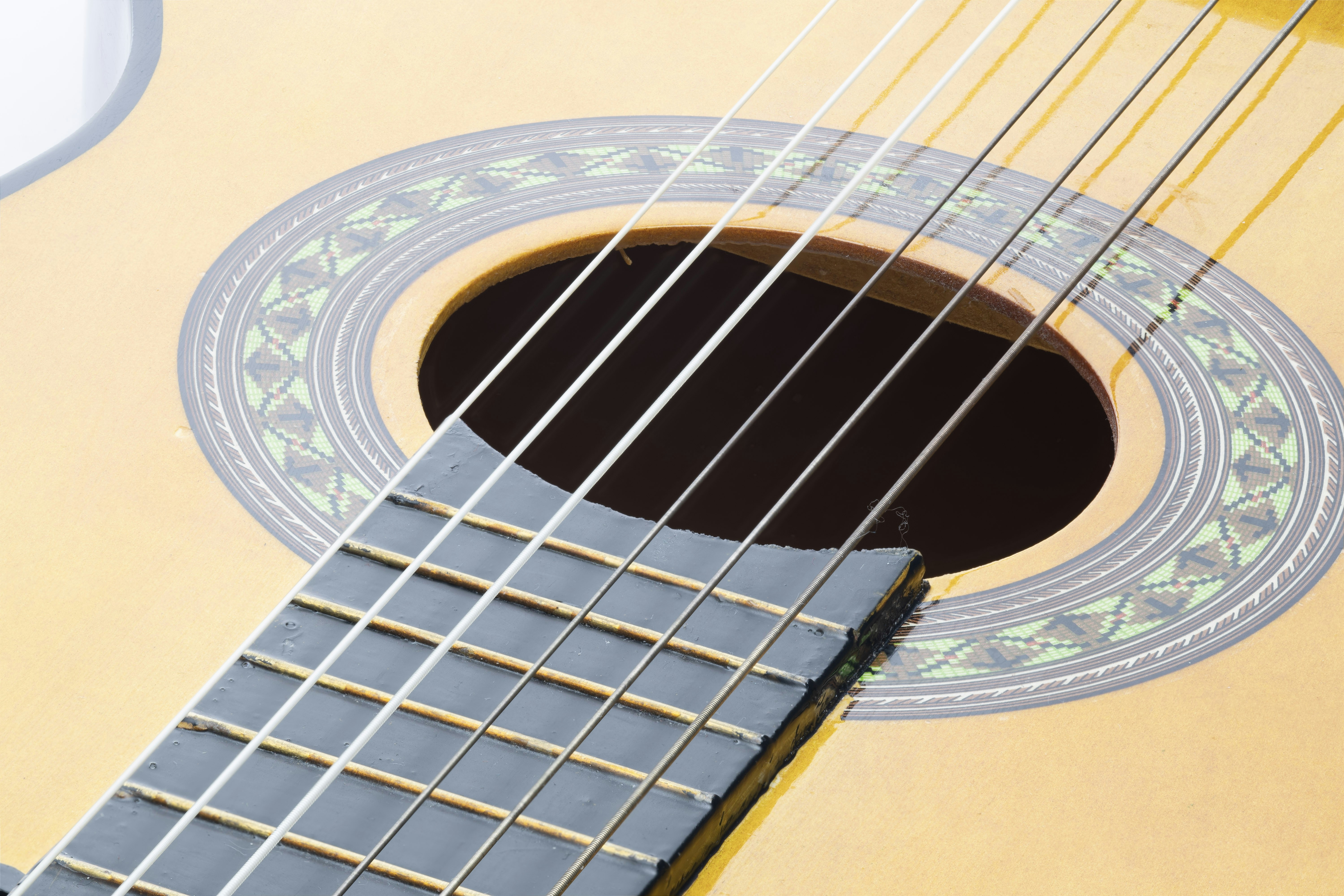 Strings Converge: Close-Up of a Classical Guitar's Soundhole and Neck
