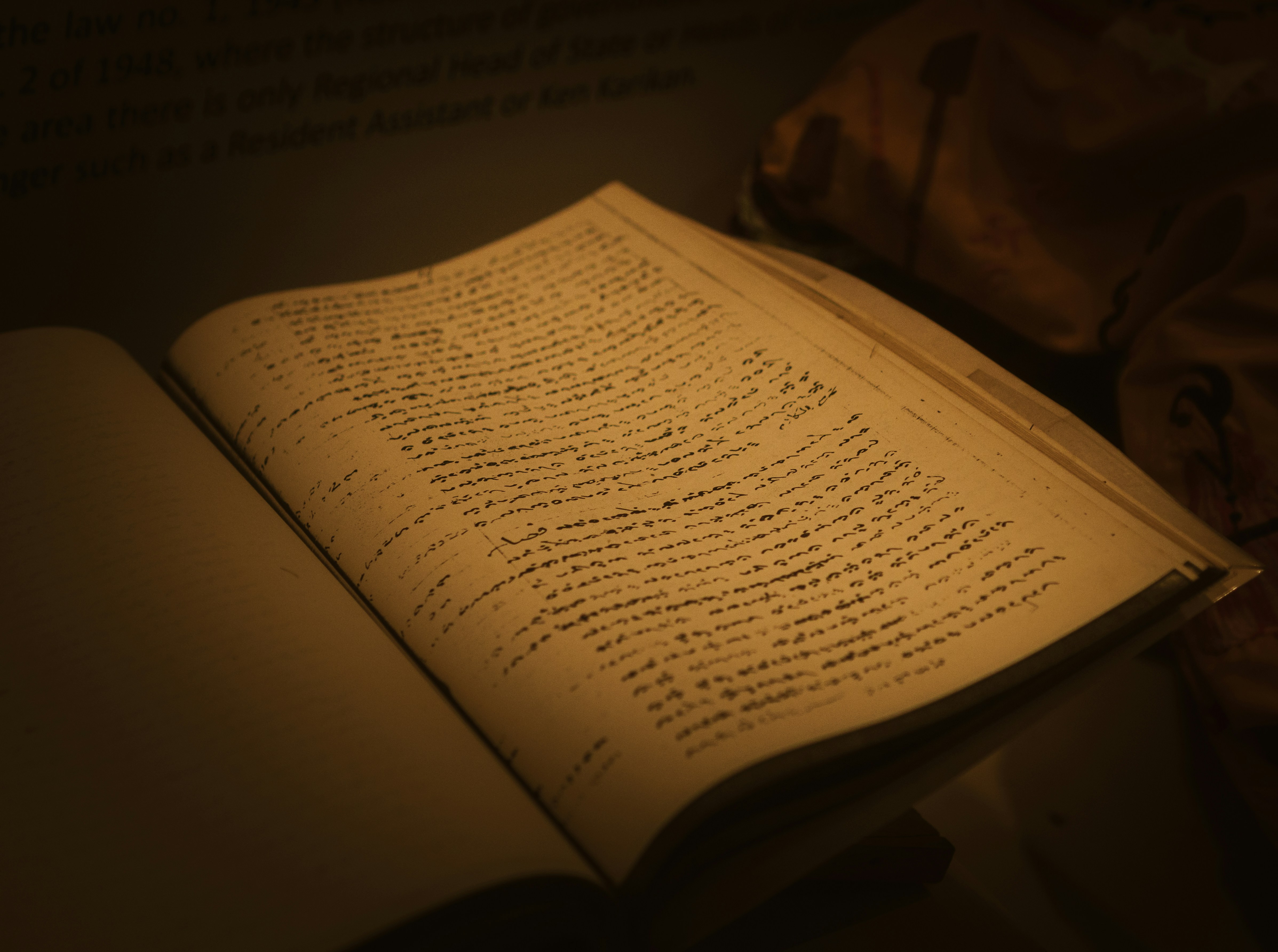 Flickering Words: An Open Page in Warm Lantern Light