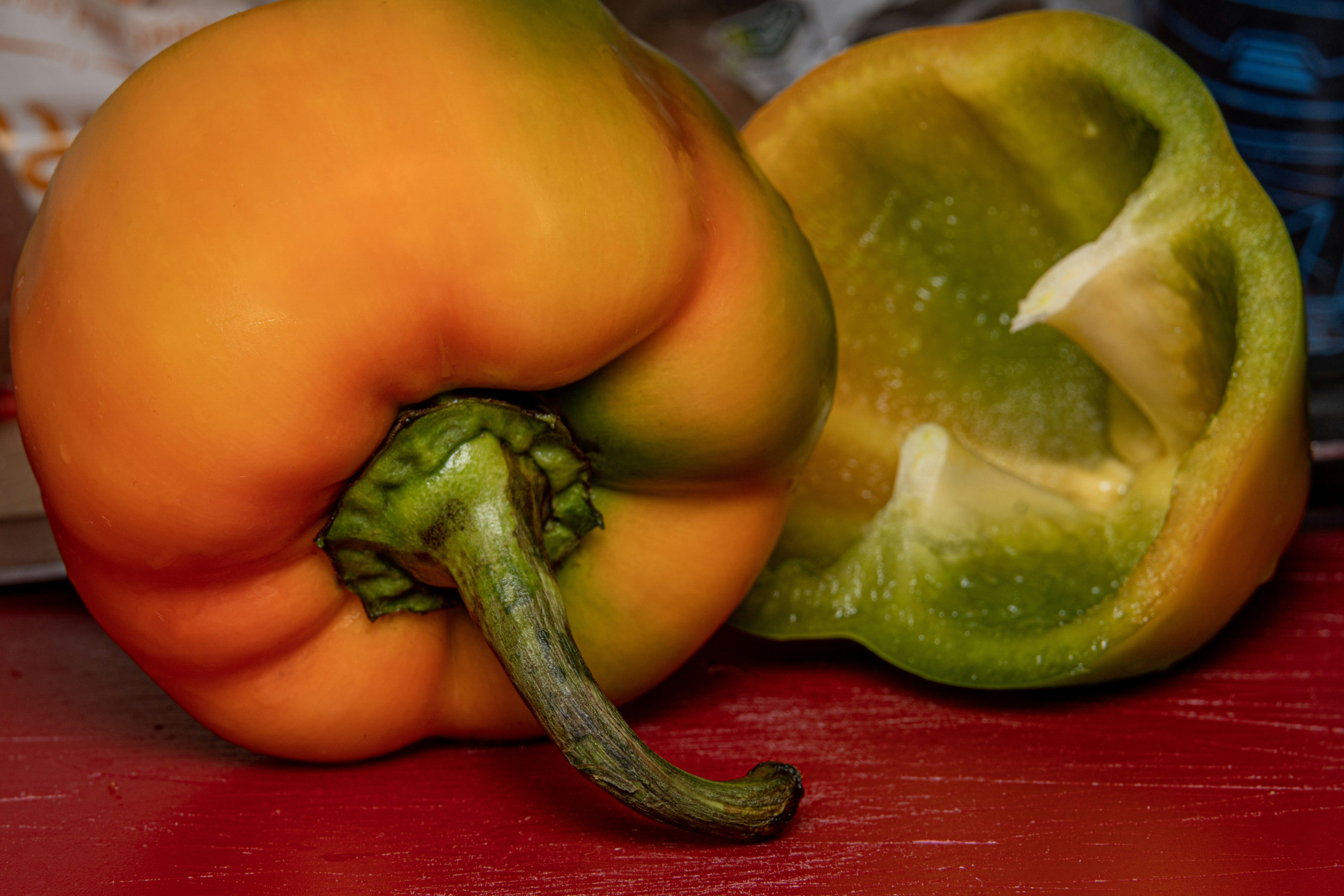 Split Pepper Portrait on a Fiery Red Surface