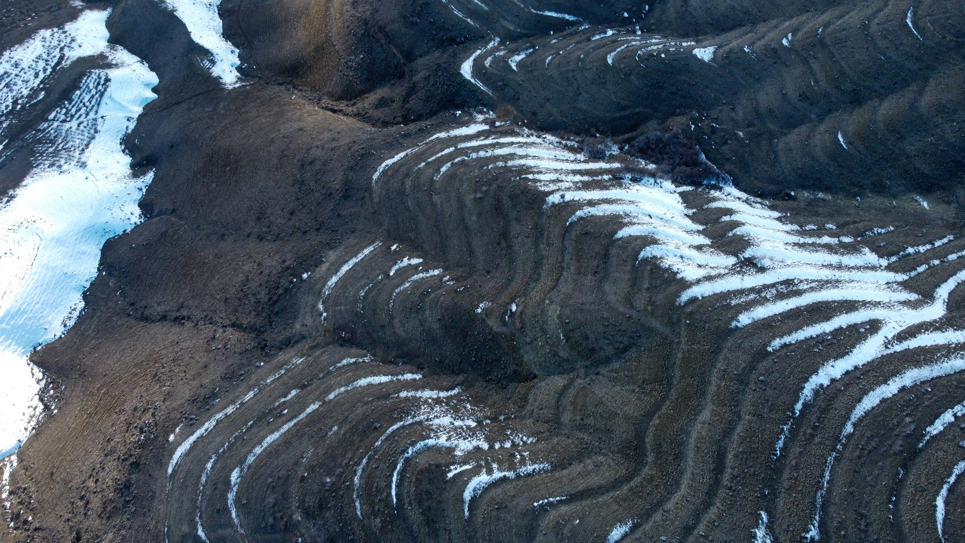 Wormlike Ridges of Dark Ash and Frost