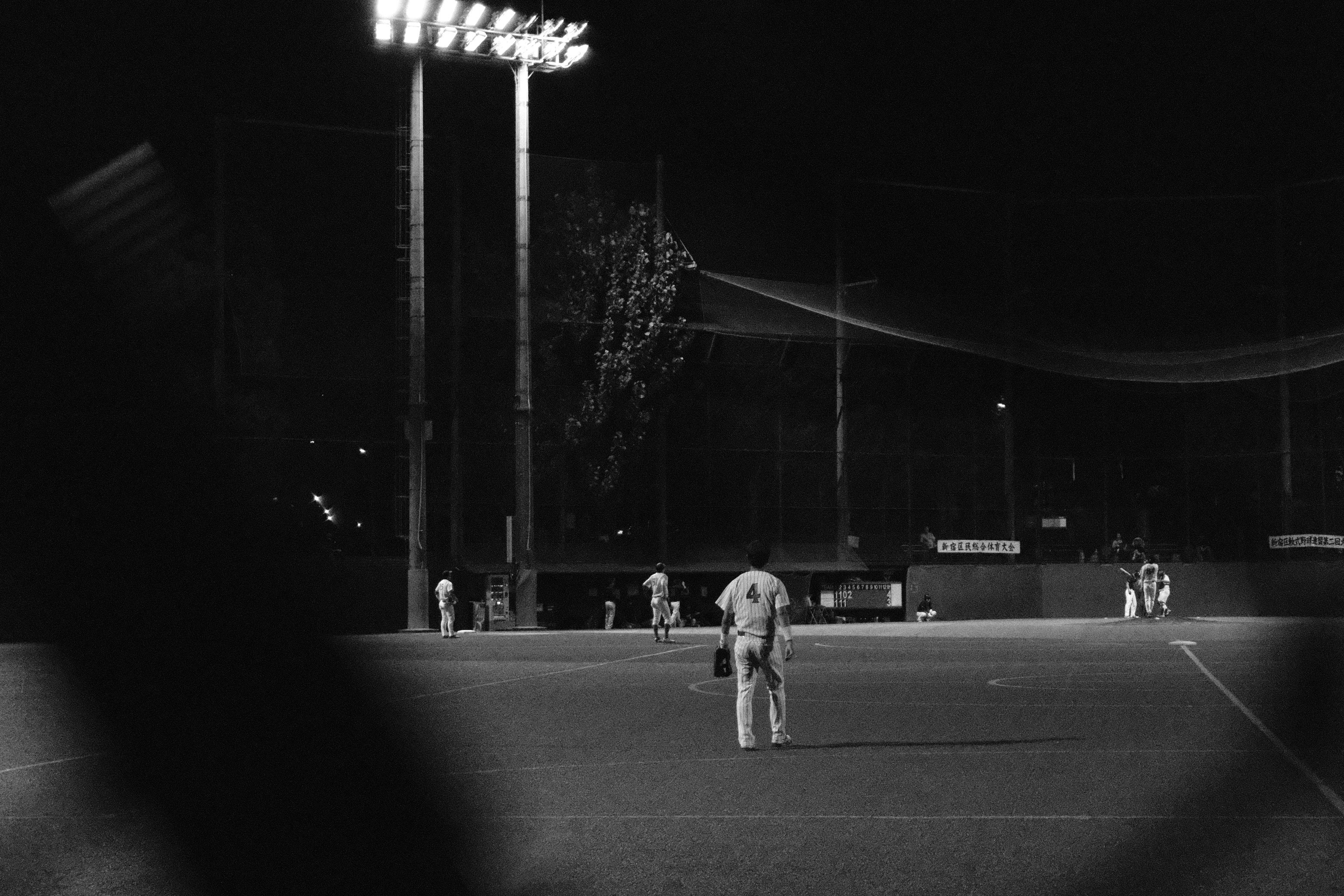 Night Field: Silent Players Under Floodlights
