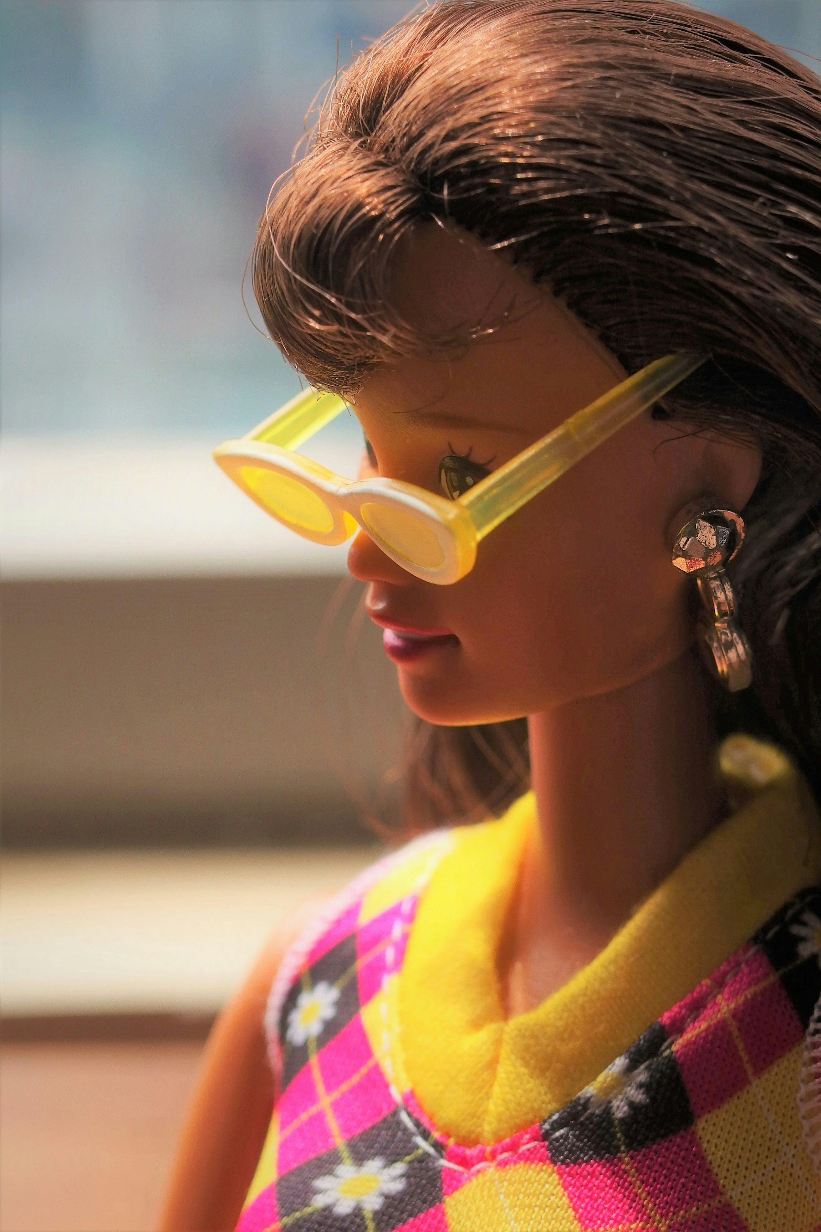 Sunny Glimpse: A Retro-Style Portrait of a Fashion Doll in Yellow Sunglasses