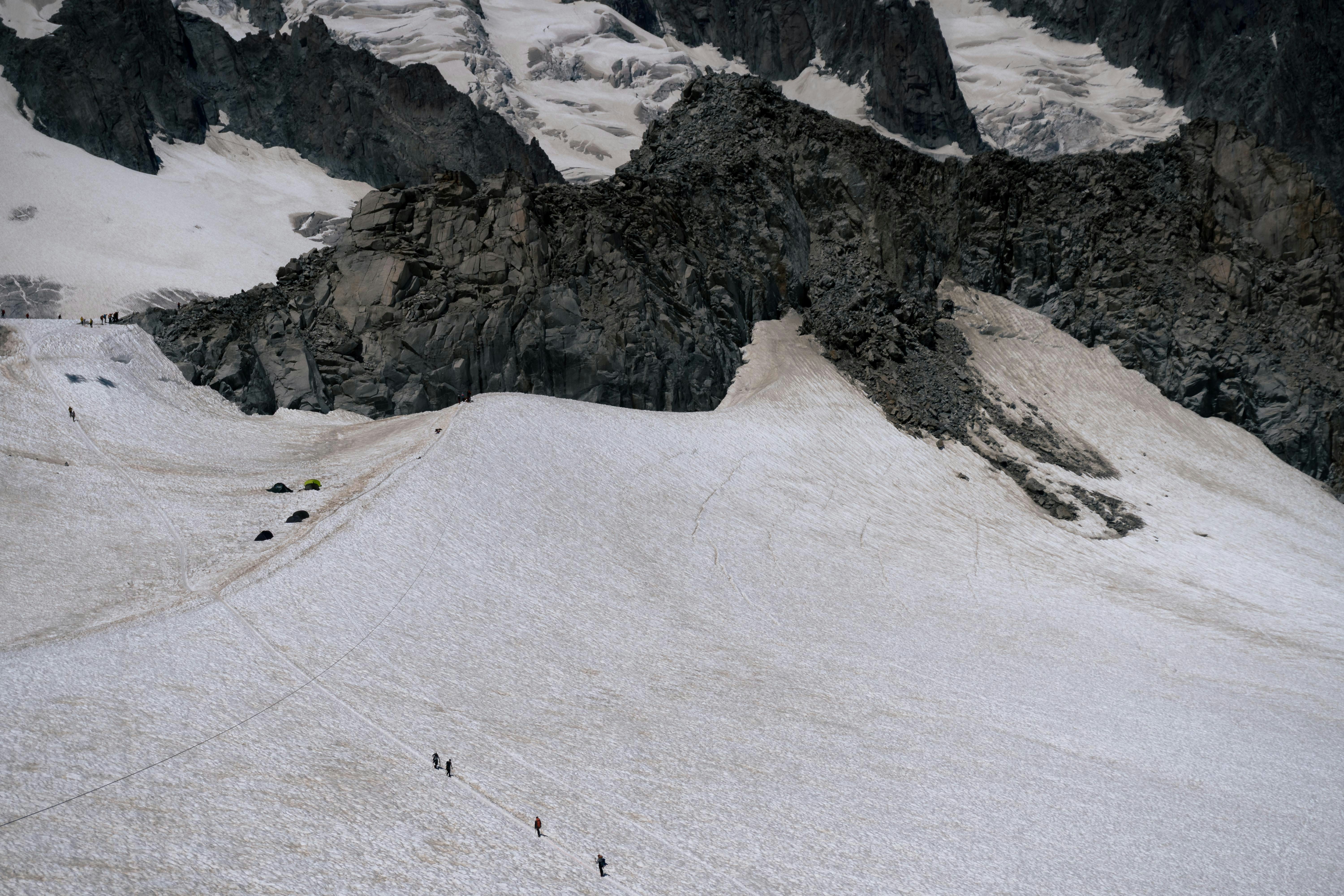 Glacial Ascent: Trails of Snow and Stone Across a Narrow Alpine Face