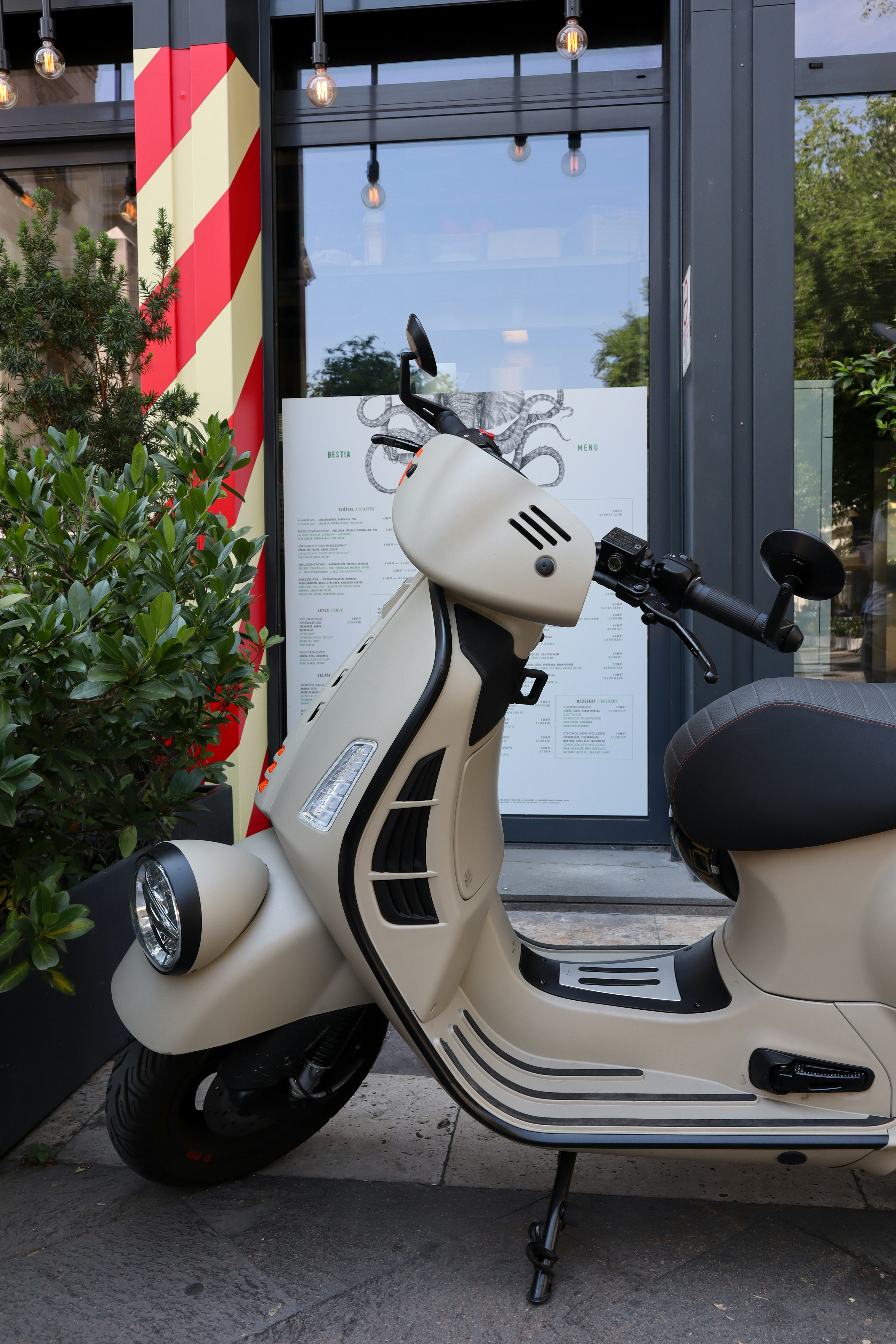 Beige Vespa at a Modern Barbershop Facade
