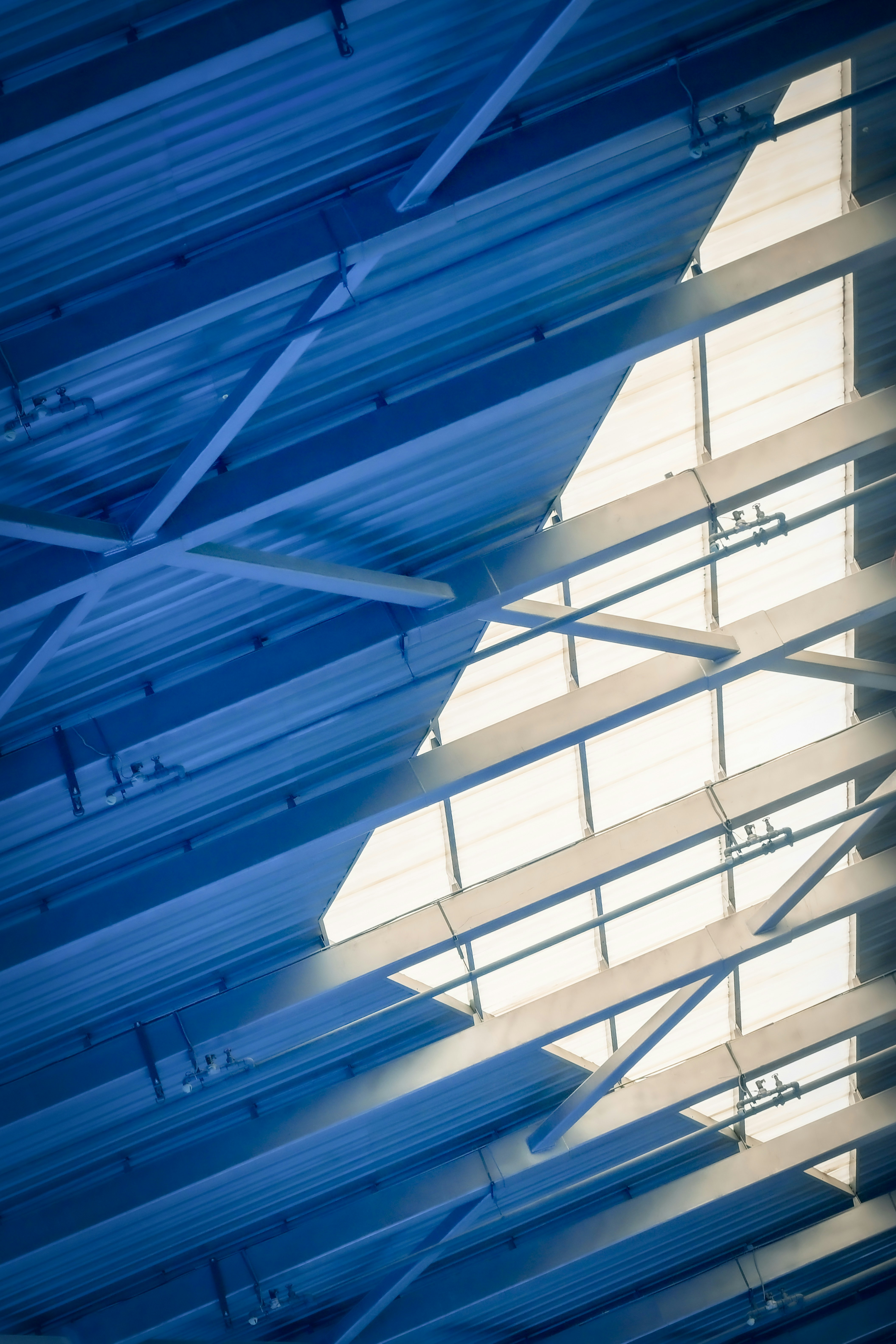 Architectural Lattice: Sunlight Through Diagonal Steel Beams