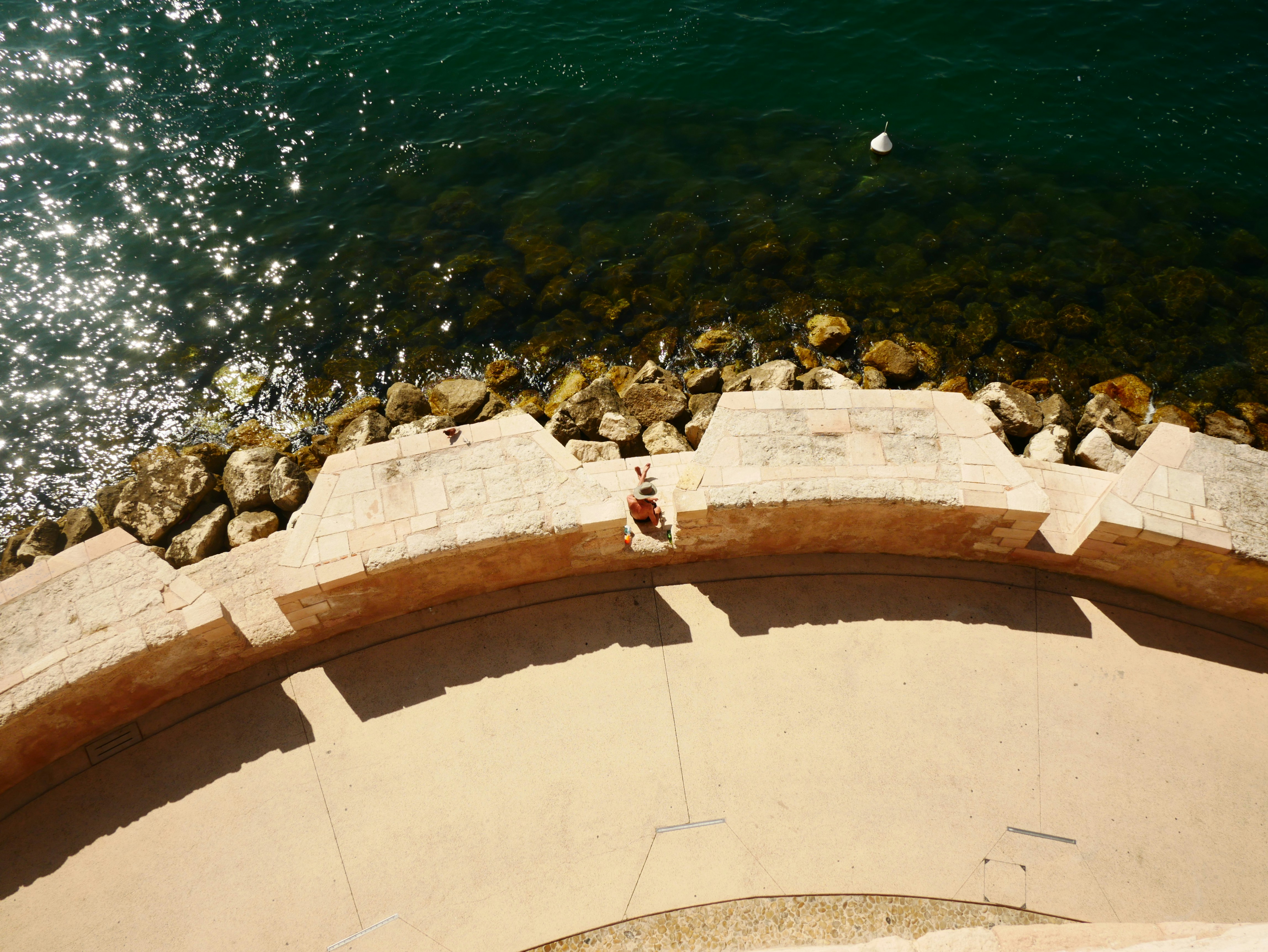 Harbor Terrace Overlook: Sunlit Breakwater and Sea Path