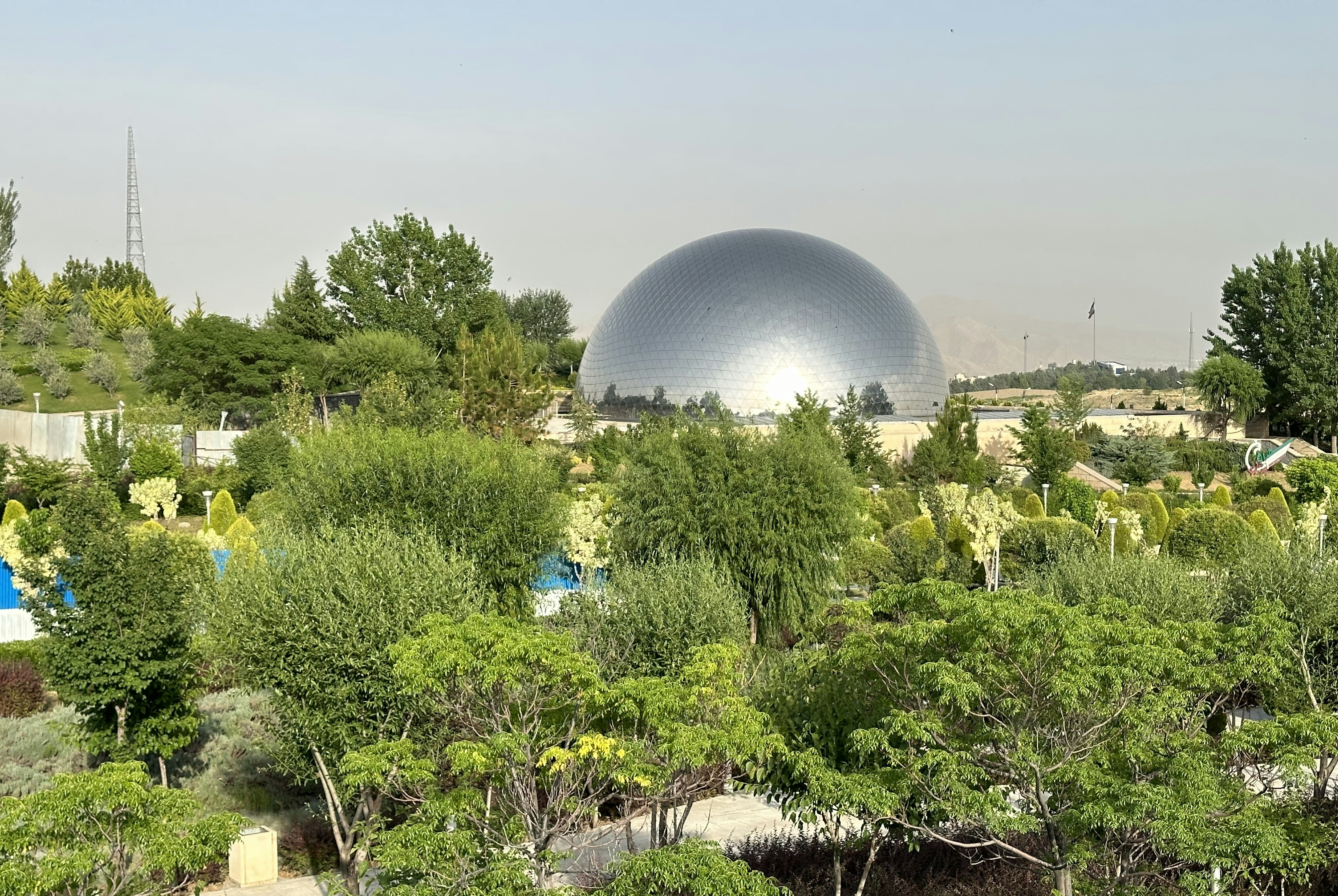 The Silver Dome Rising Beyond a Green Canopy