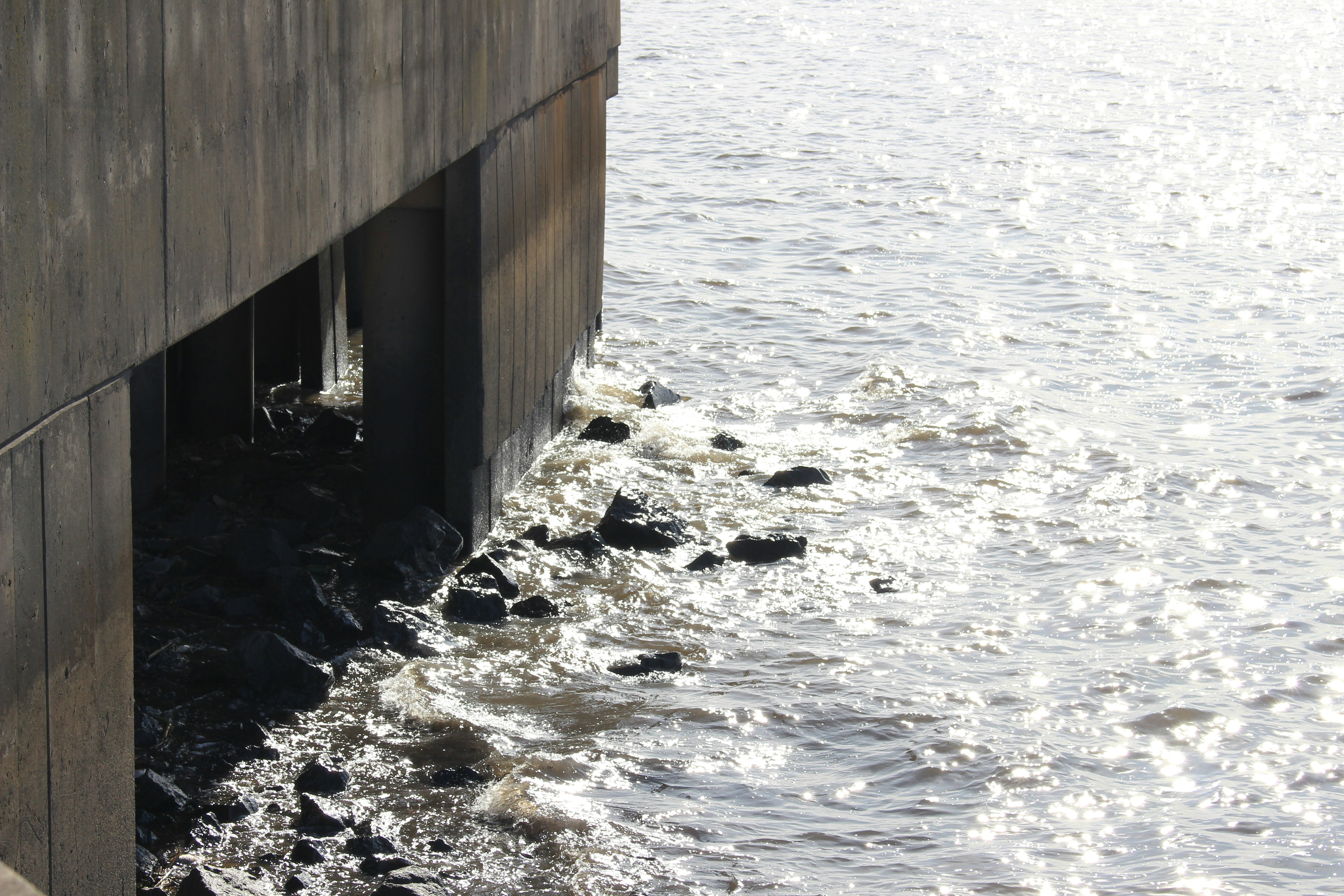 Shadowed Pier Edges Meet Glinting Water