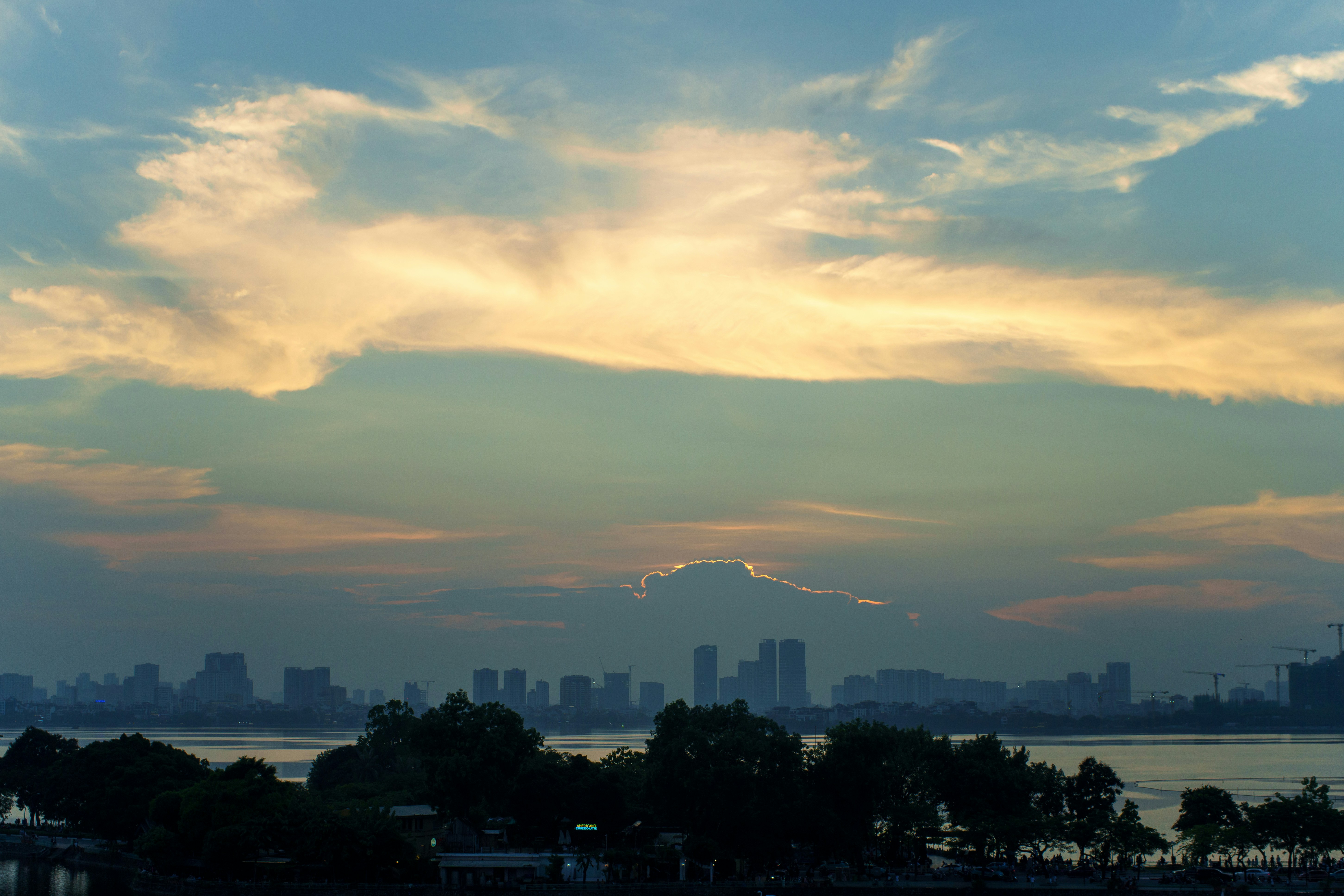 Silhouette of a Skyline at Sunset Over Calm Water