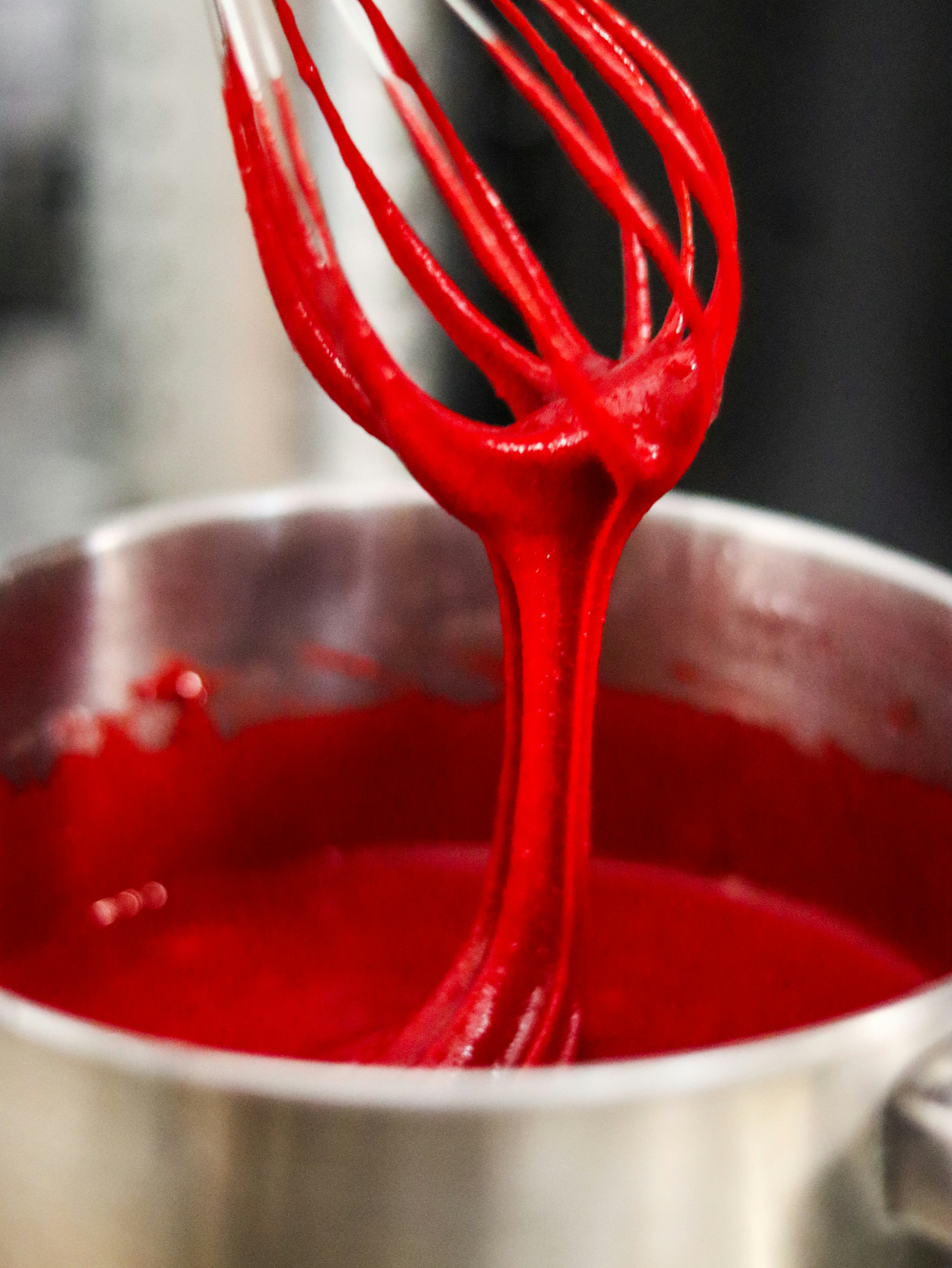 Crimson Whorls: A Ribbon of Sauce in a Stainless Cup