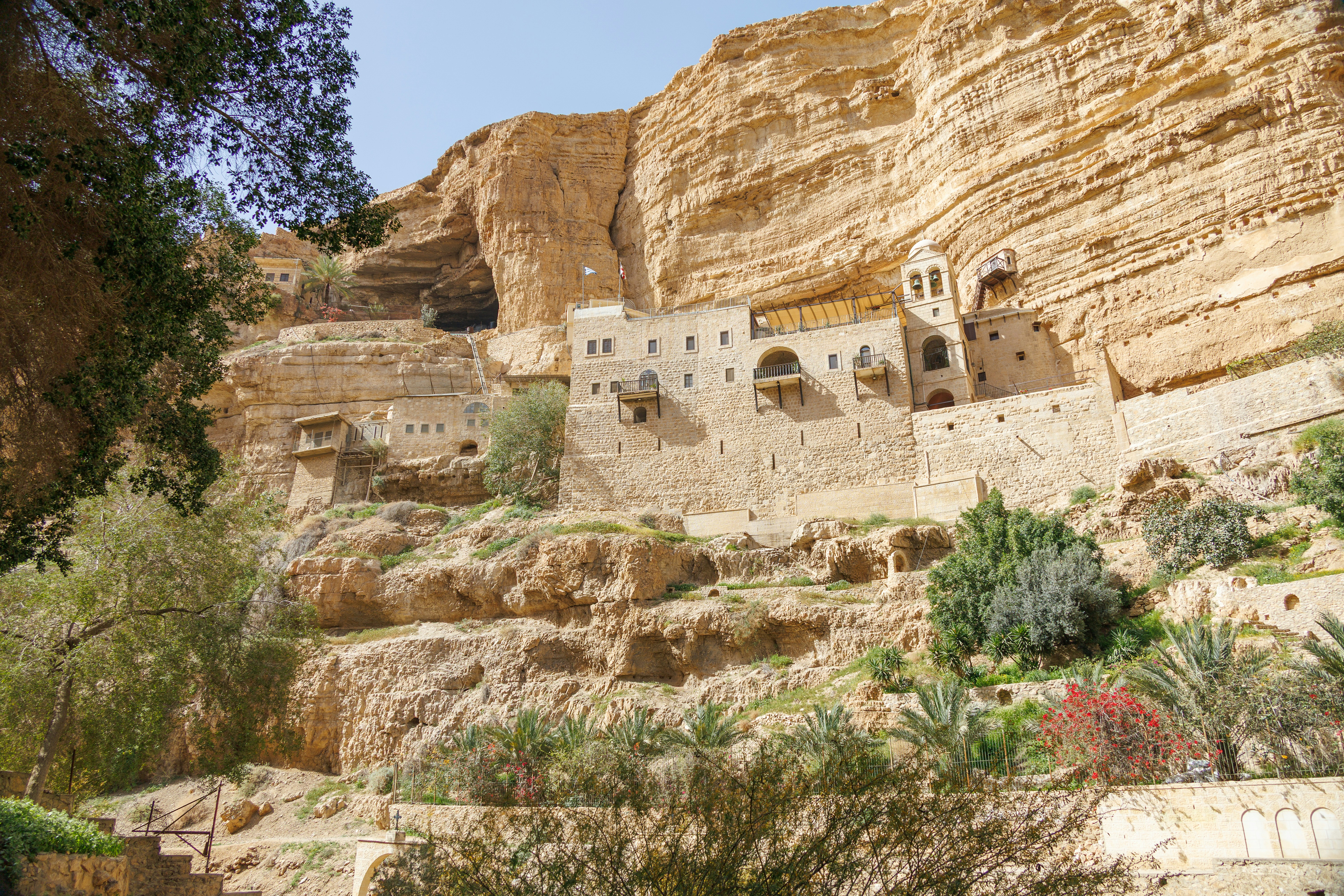 Cliffside Monastery Emerges from Stony Walls Under A Clear Sky