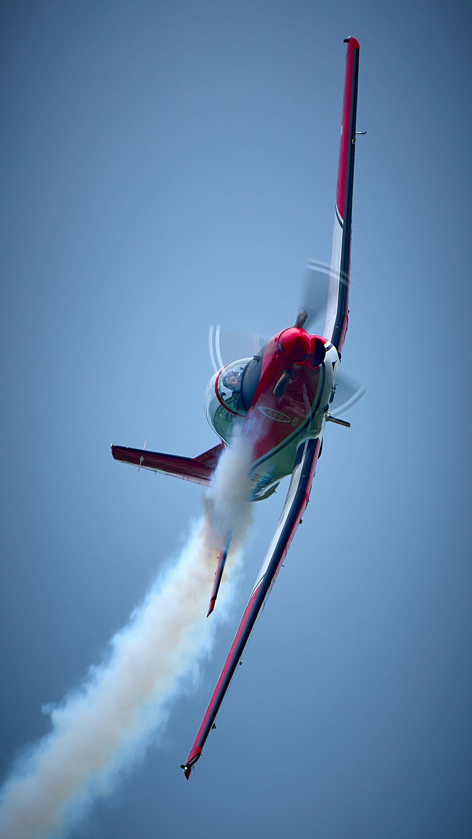 Red Thunder: a high-contrast aerobatic display from a dynamic biplane trail