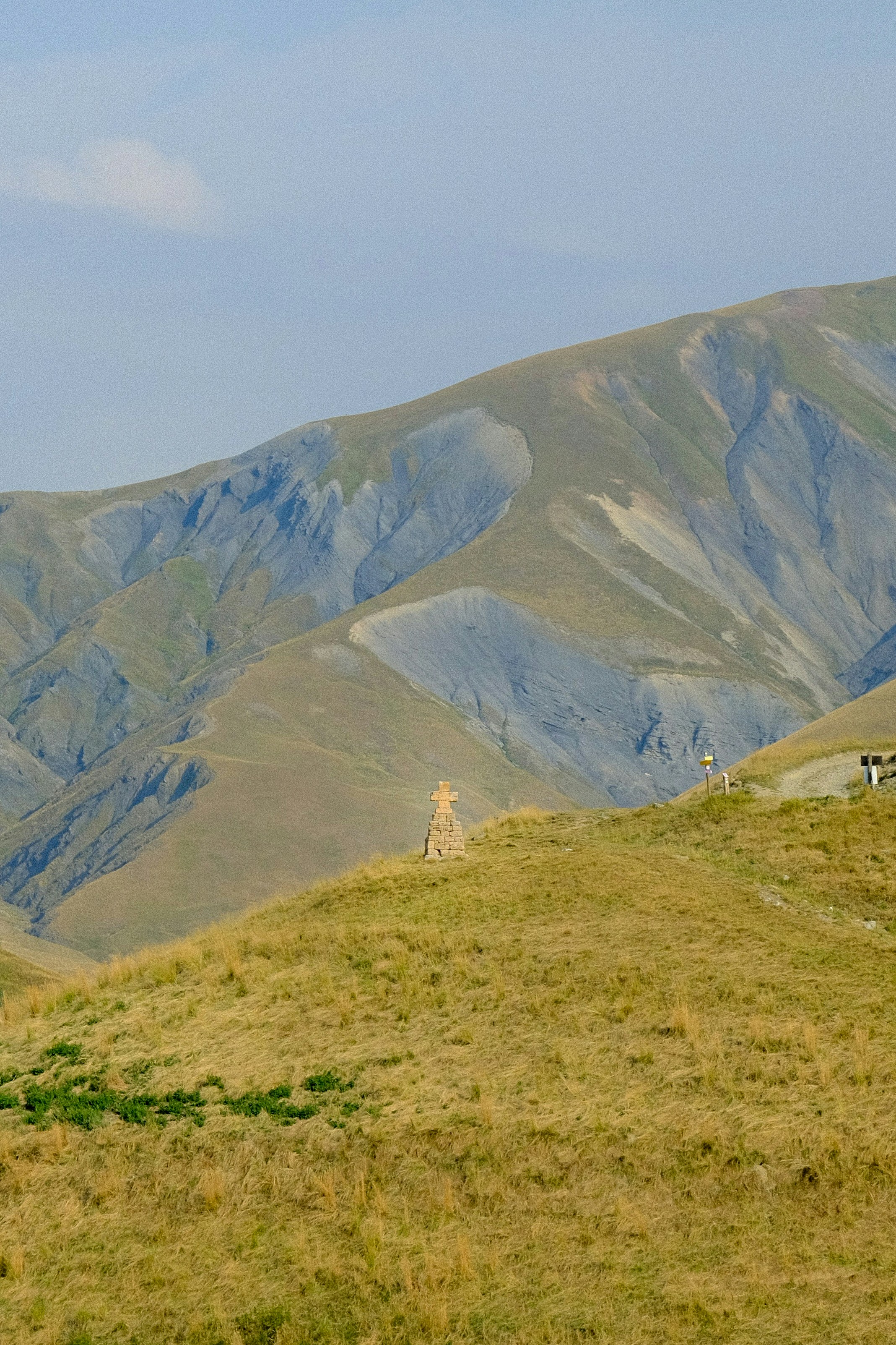 Stone Marker on Quiet Ridge Above the Rolling Hills