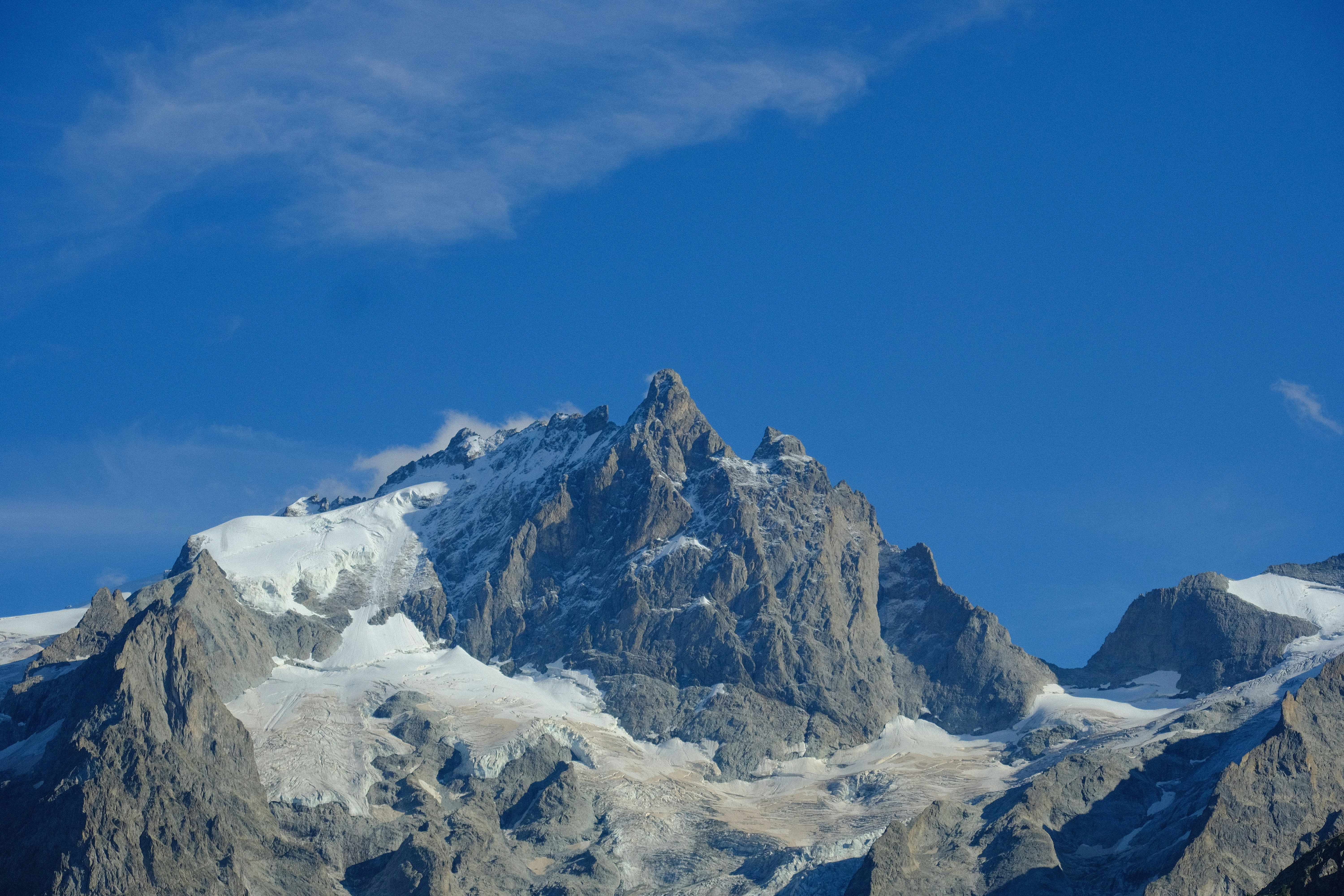 Peak Crown: A Jagged Summit Beneath a Clear Blue Sky