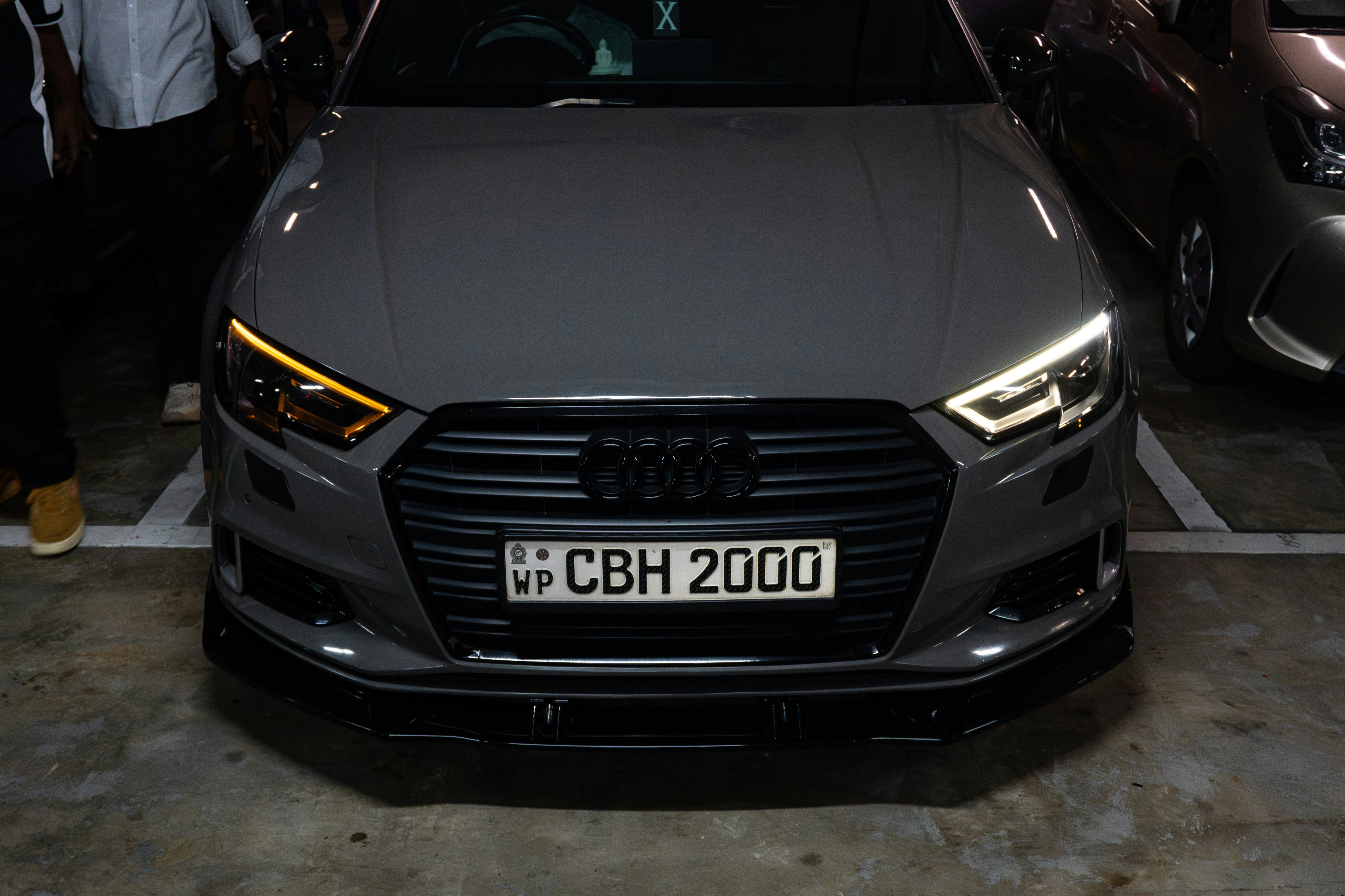 Midnight Grille: Audi-like Silhouette in a Dim Parking Deck