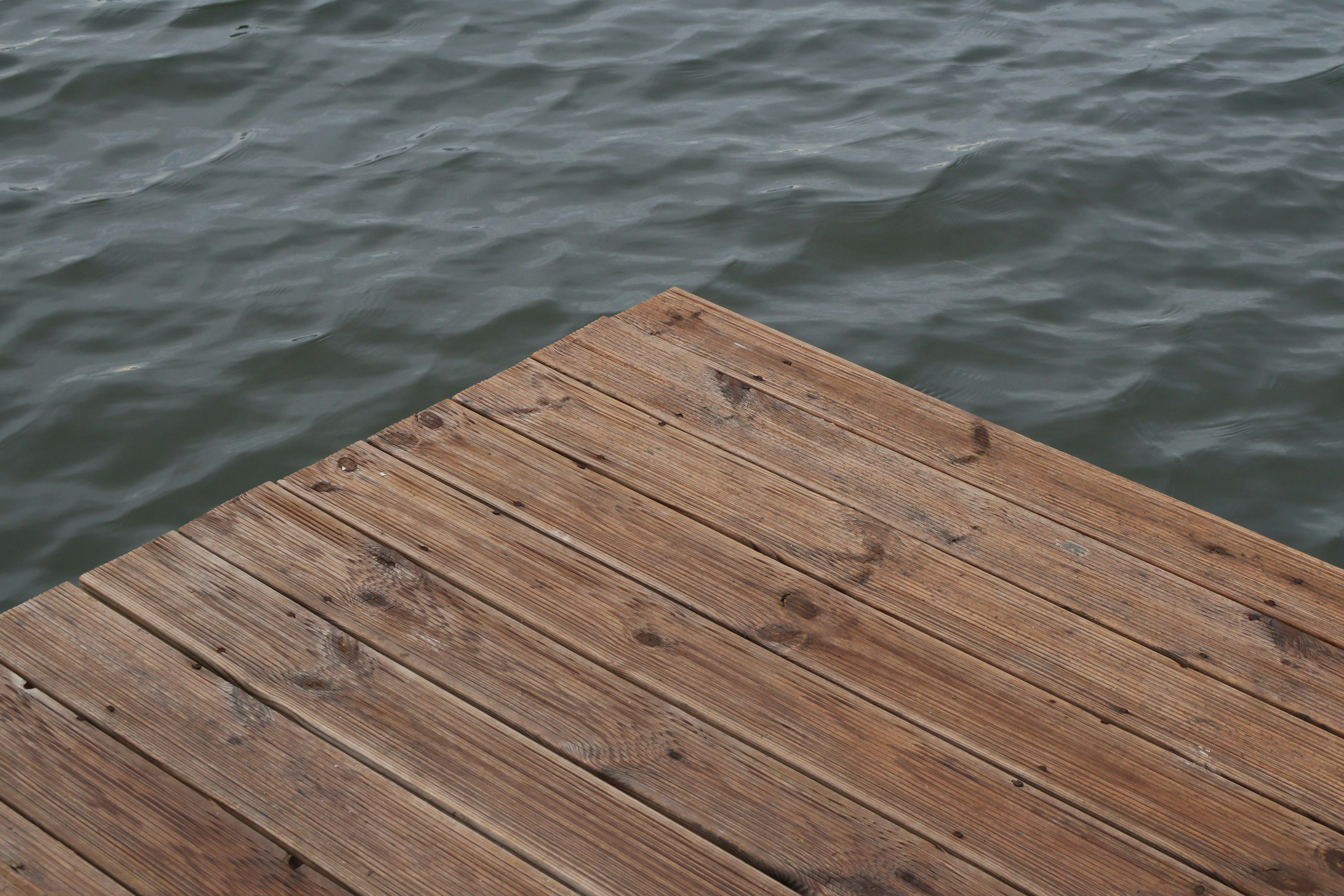 Wooden Dock Edge Over Calm Water