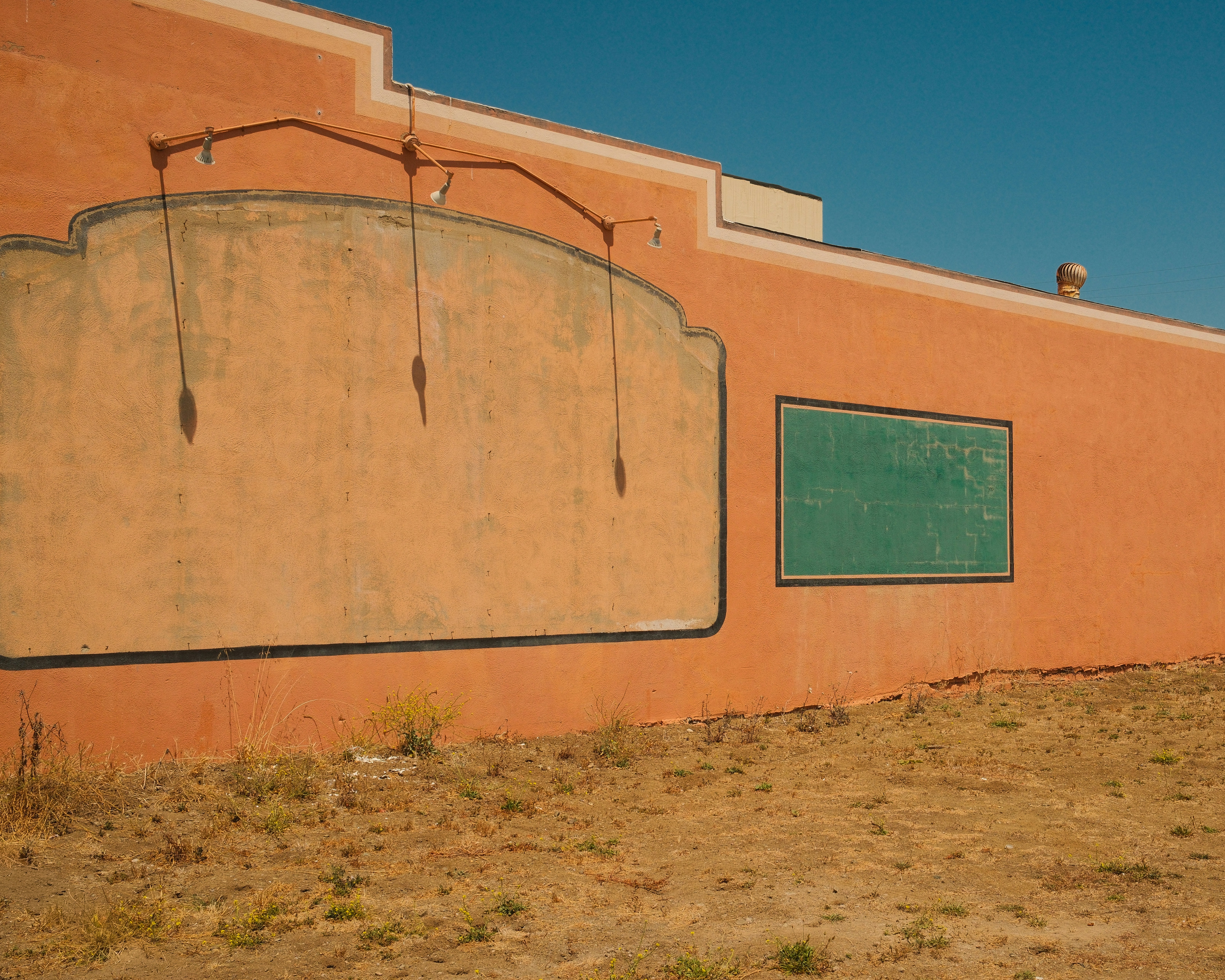 Deserted orange building wall with two blank signs