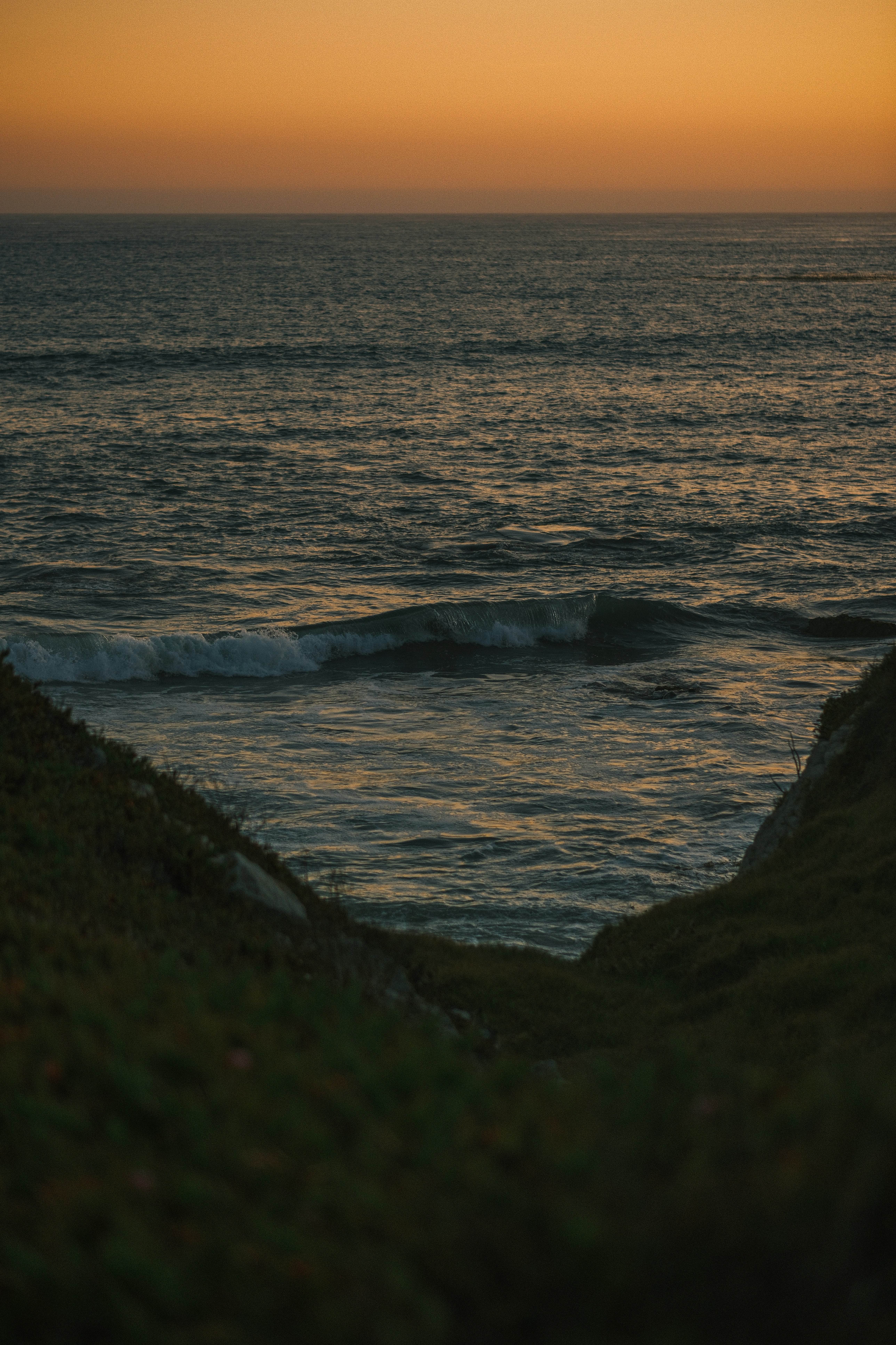 Sunset Over a Quiet Seascape Between Coastal Dunes