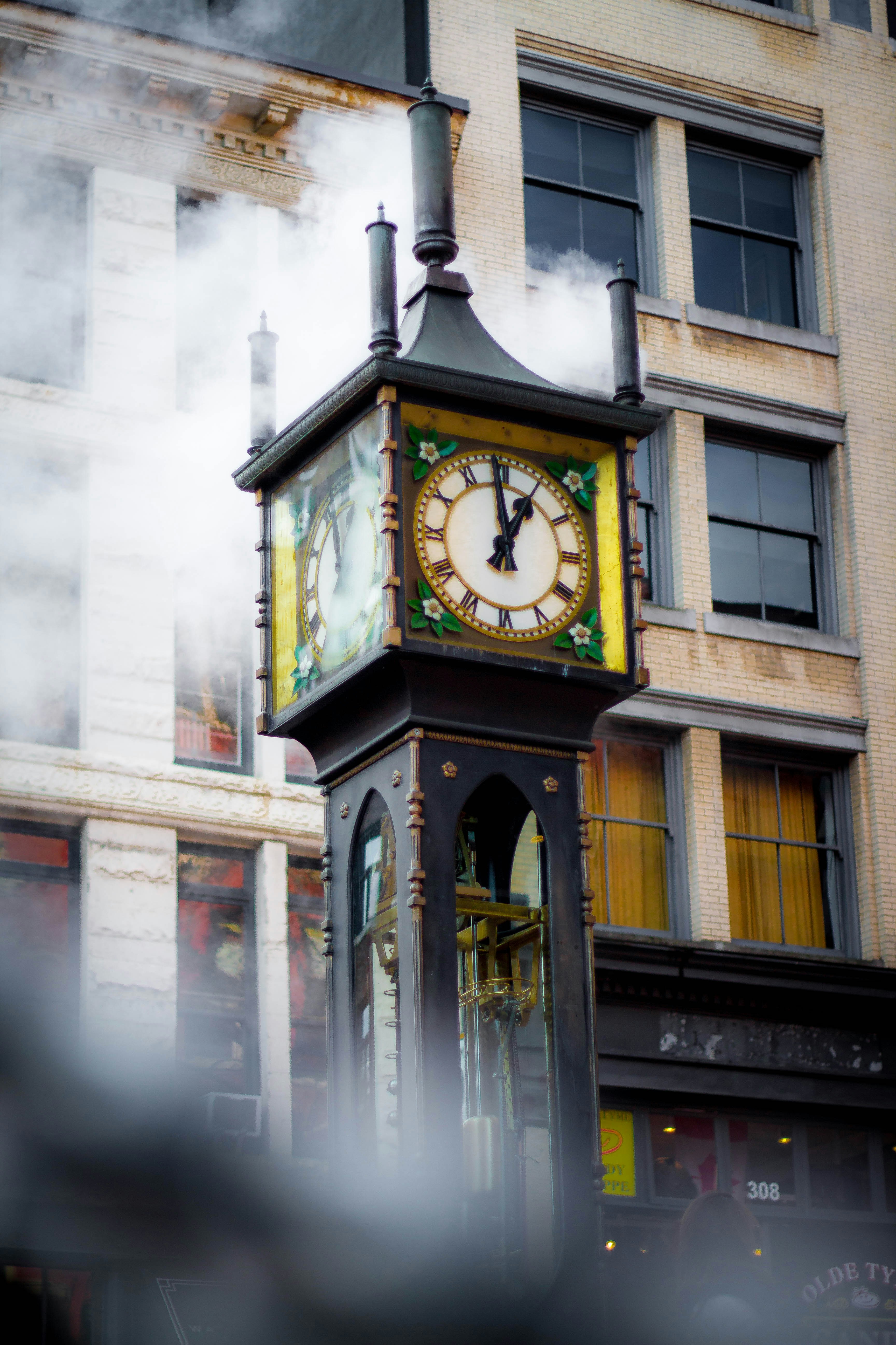 Steam and Time: A Clock Tower Emerges from the Misty Street