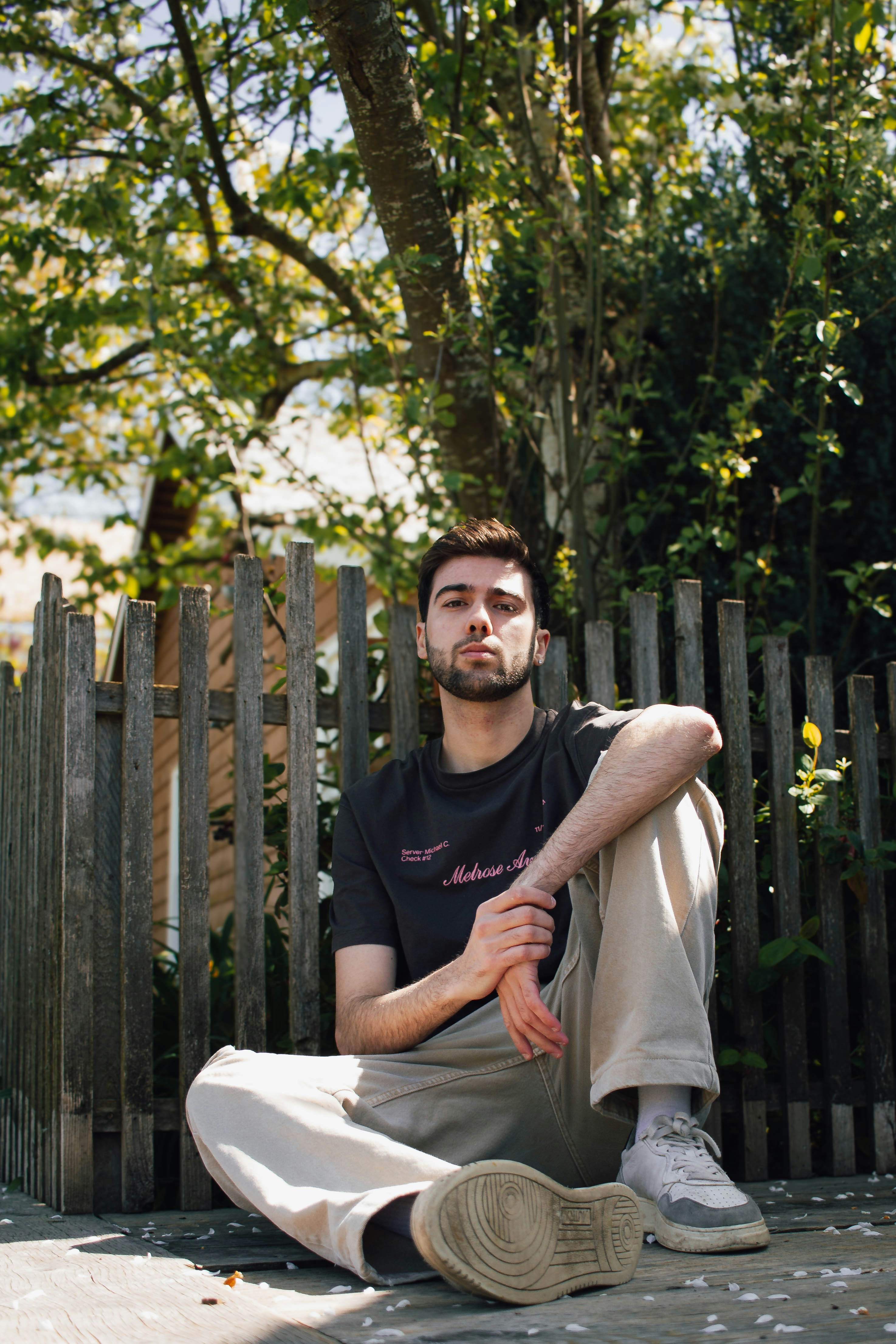 Sitting in the Sunlight: A Quiet Moment by the Fence