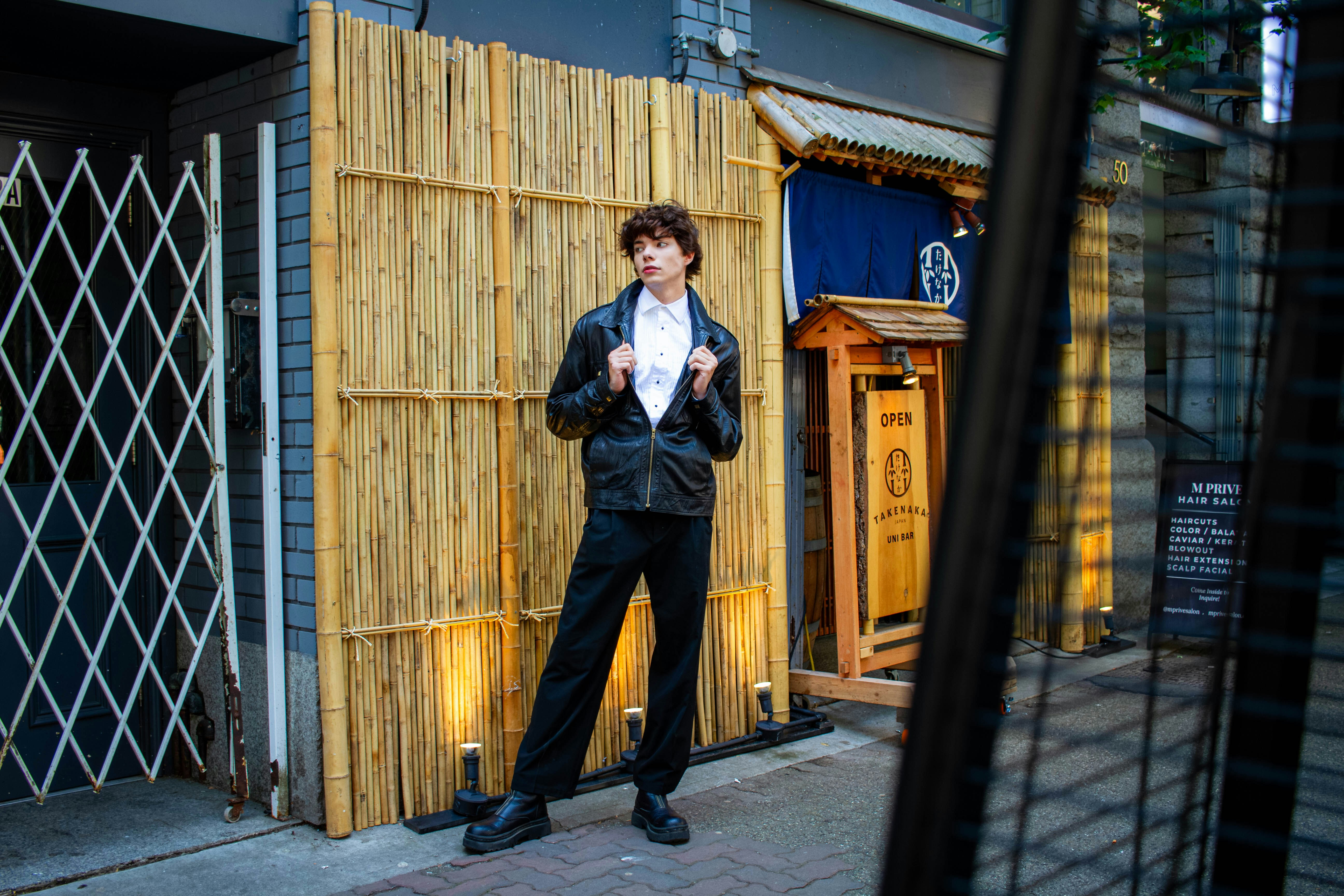 Urban Bond: A Portrait of Confidence on a Neon-Fenced Street