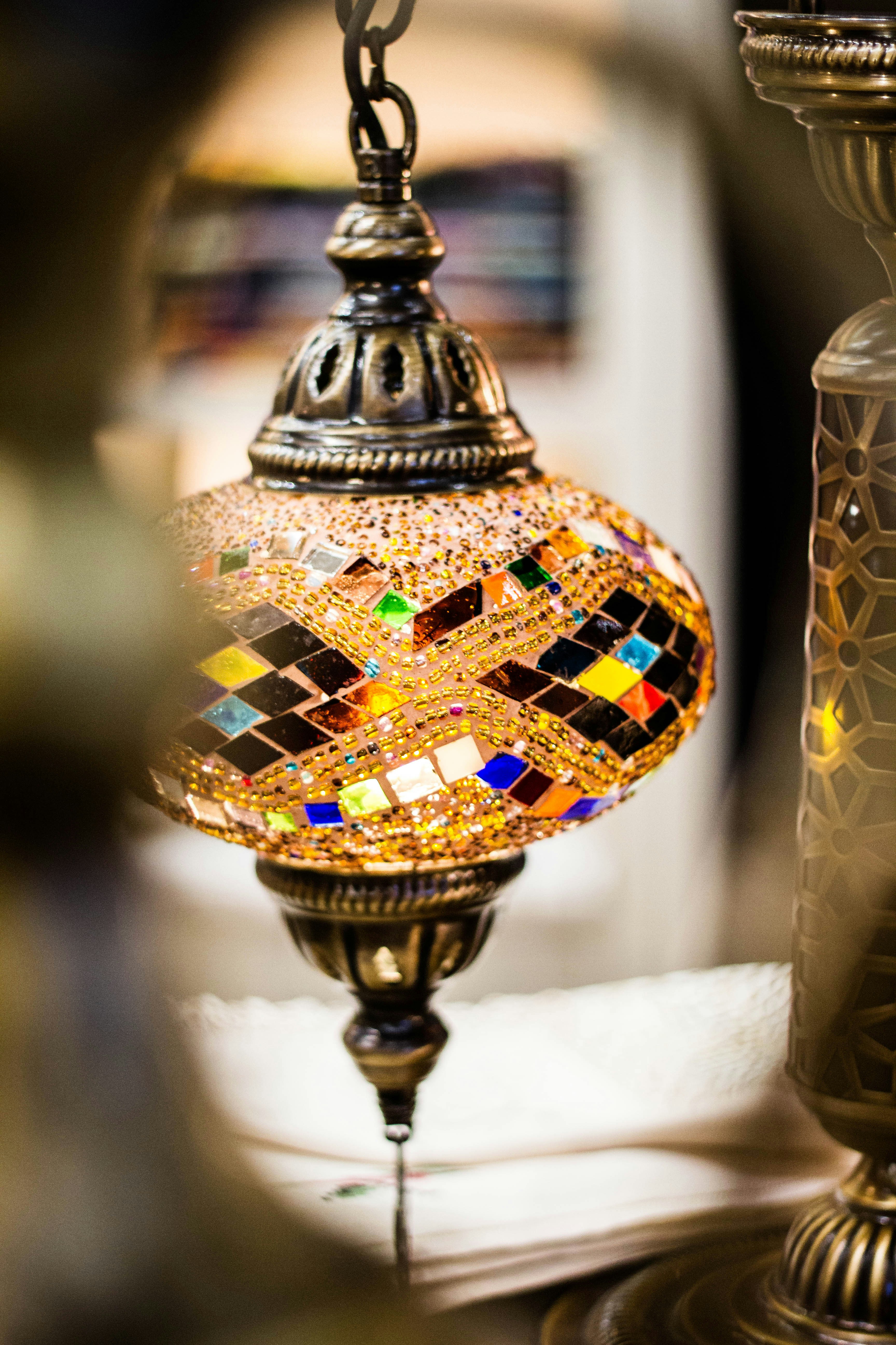  Mosaic lamp pendant: warm glass mosaic catching light amid ornate metalwork