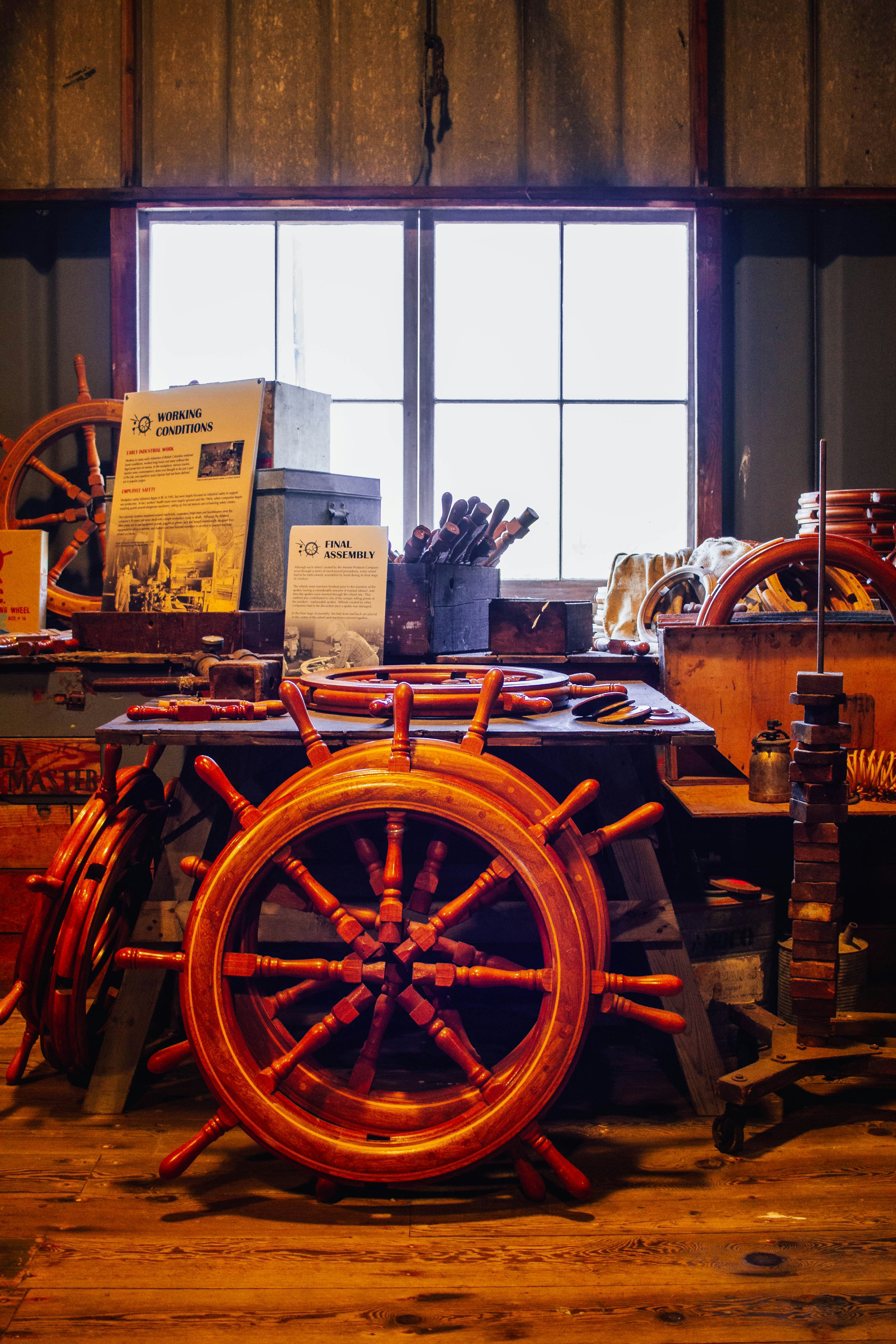 Orange Ship Wheels in a Workshop: A Quiet Nautical Moment