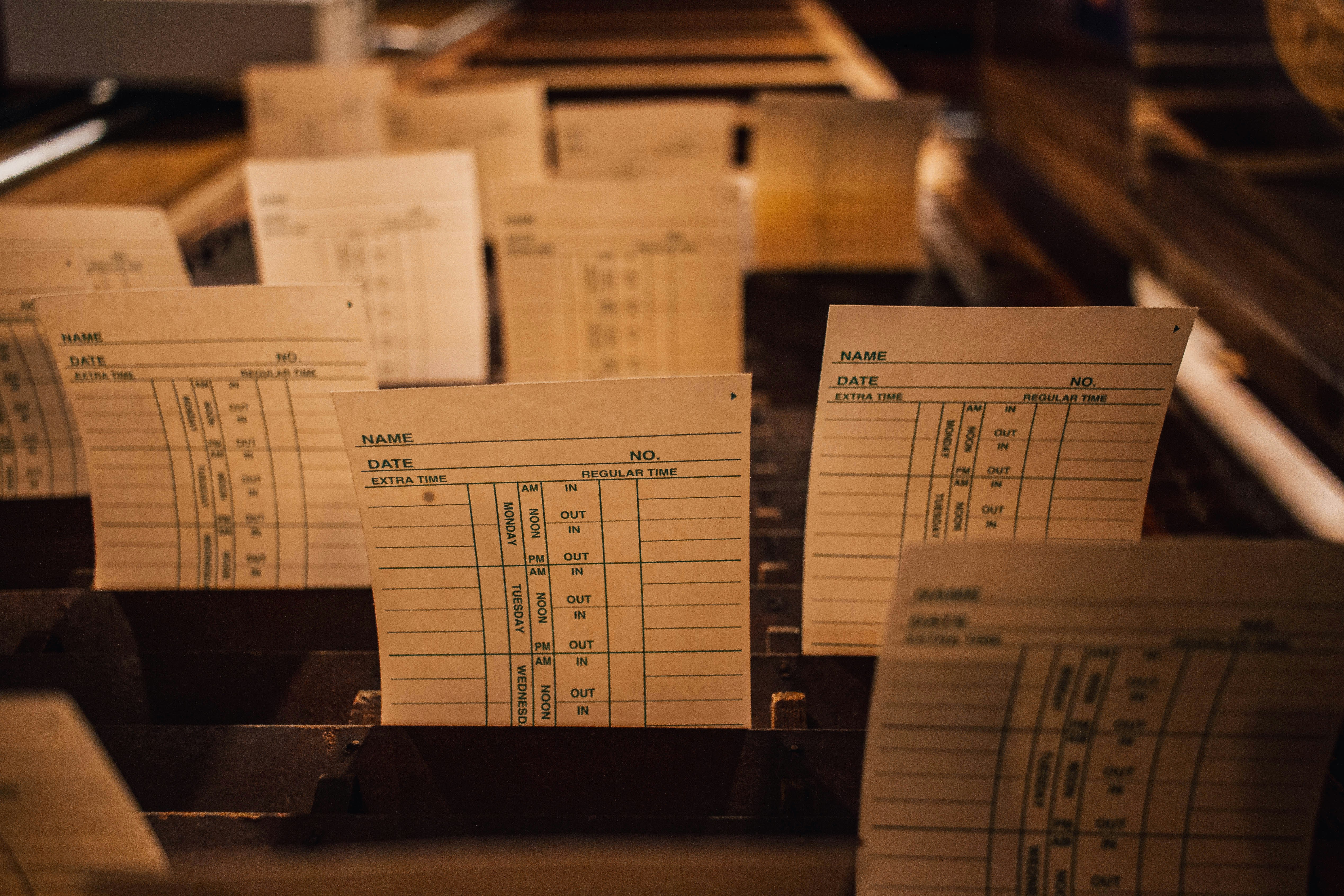Filed Receipts in a Wooden Tray: Rows of Perforated Documents
