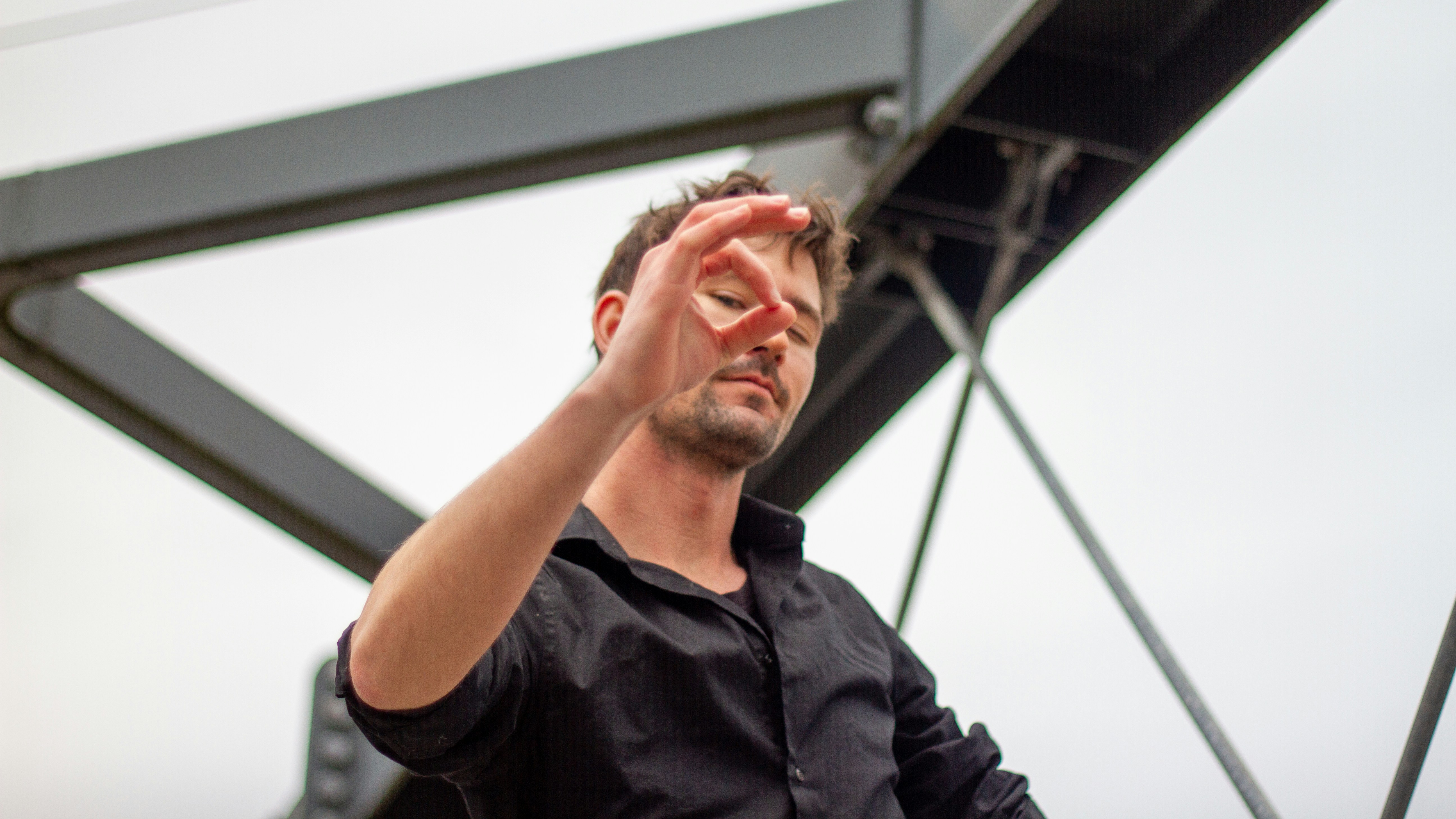 Gesture in Steel: A Portrait of Focus Amid Industrial Lines