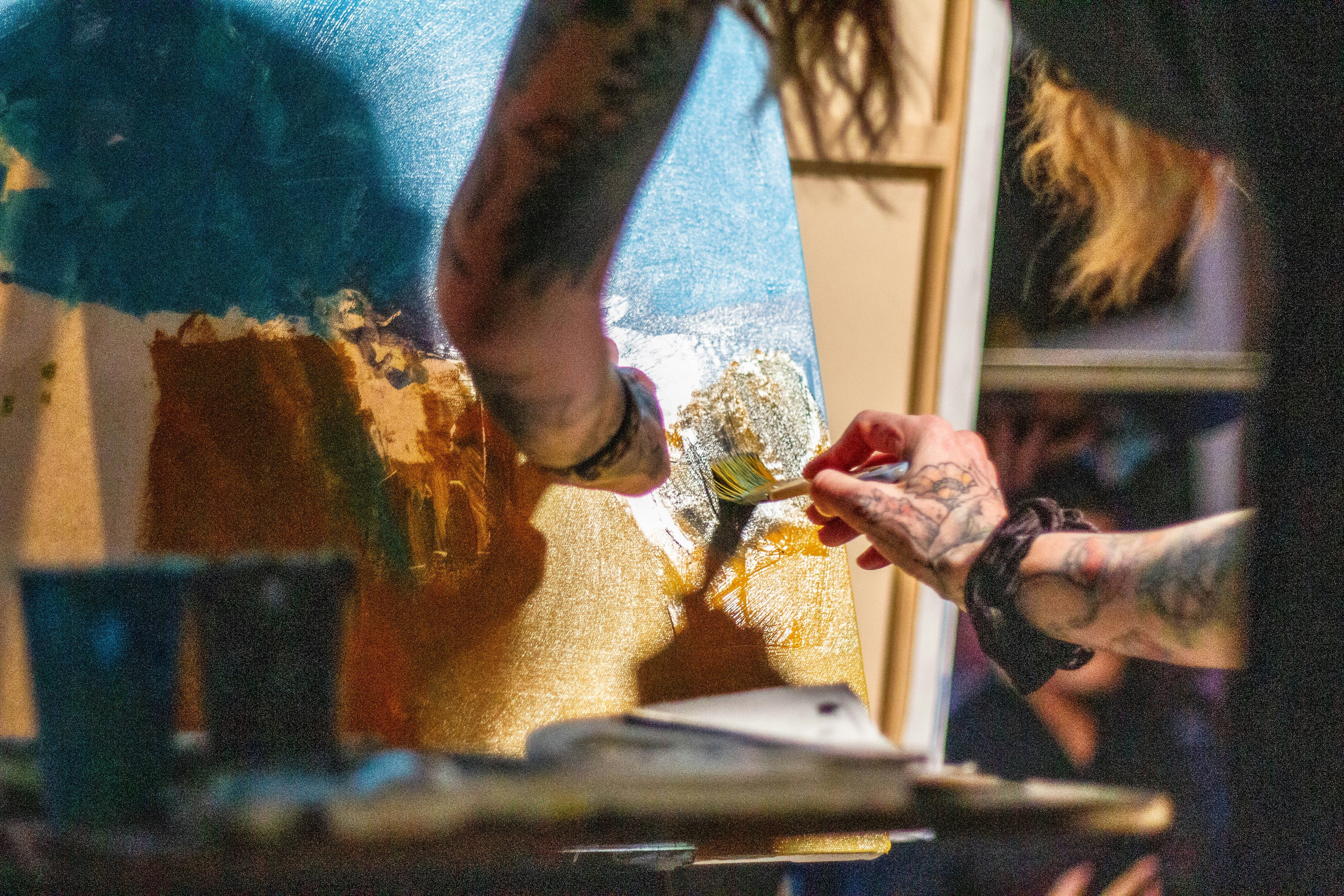 From Canvas to Craft: Hands at Work on Gold Leaf and Ink