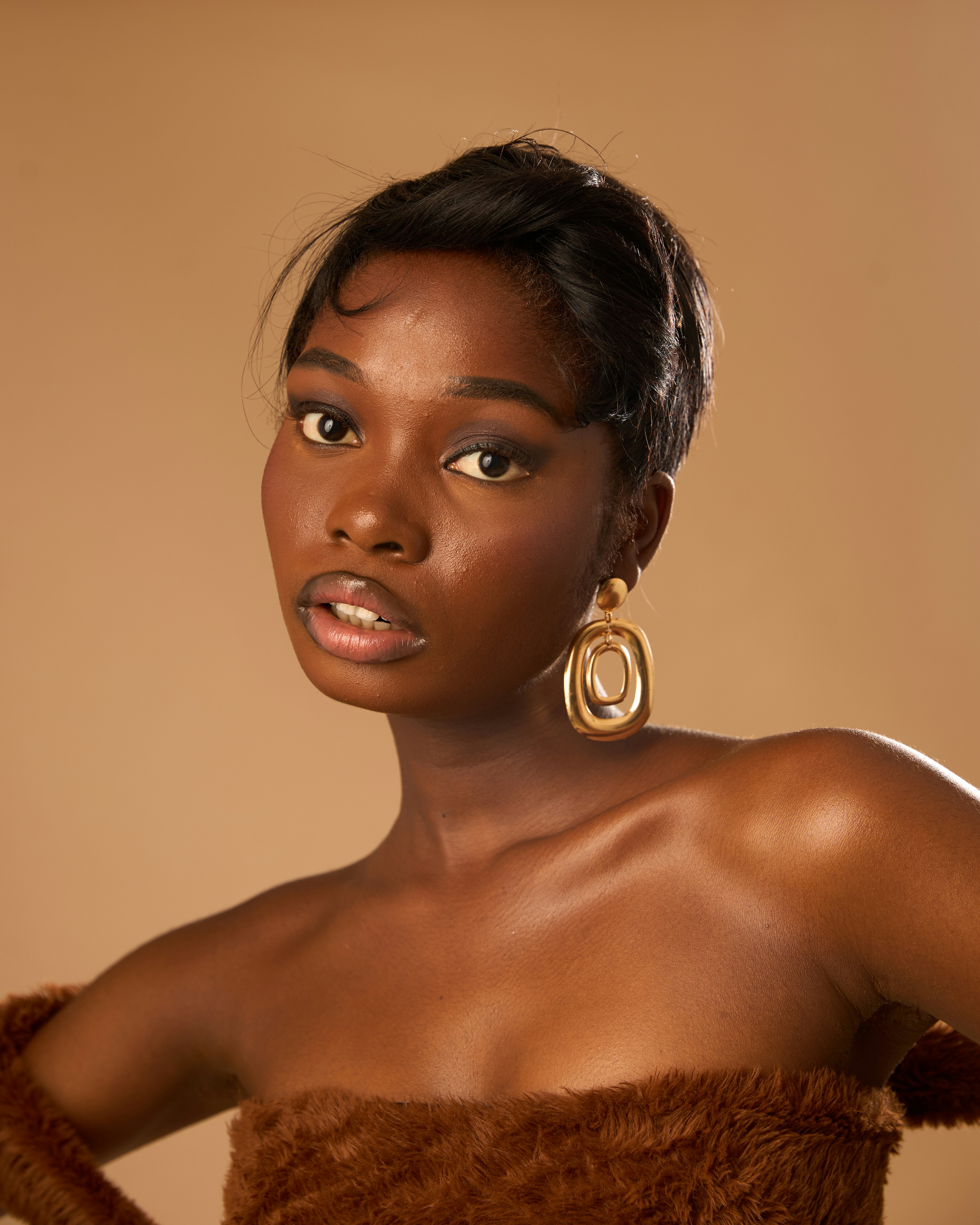 Golden Glow: Portrait of Confidence in Warm Studio Light