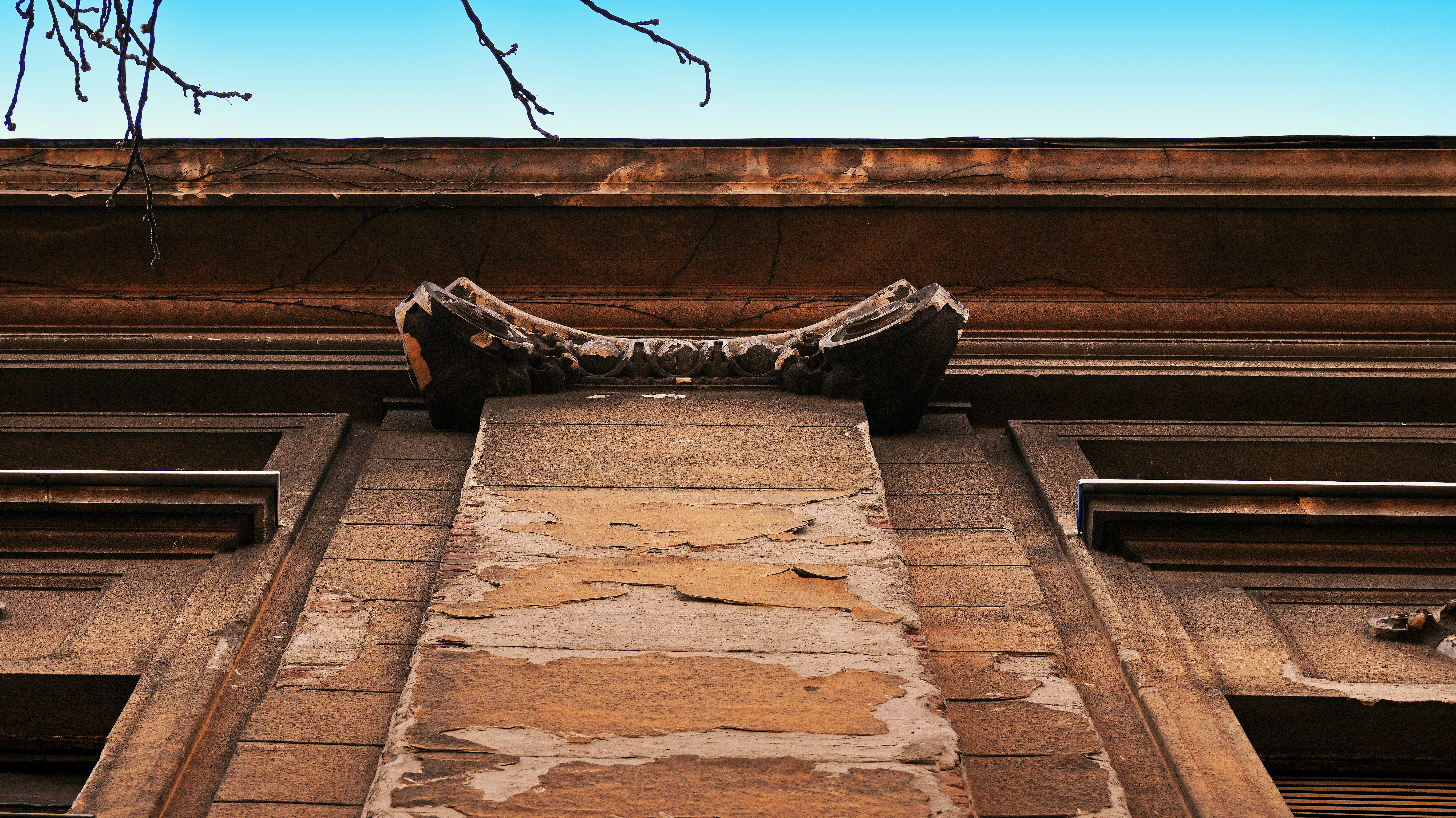 Weathered Keystone: Weathered Stone and Framing Over a Historic Facade