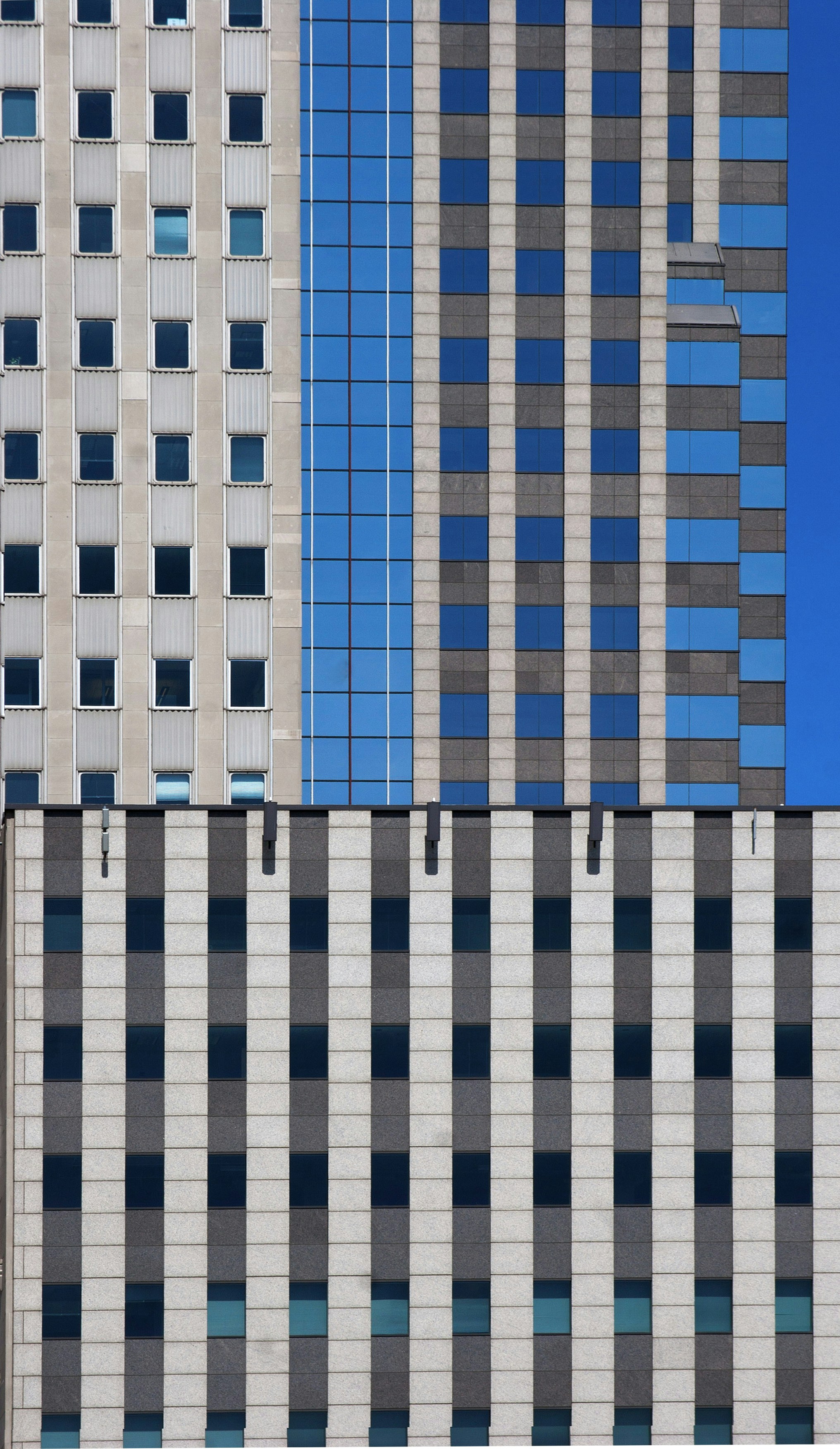 Vertical Facades: A Tiled Symphony of Blues and Grays