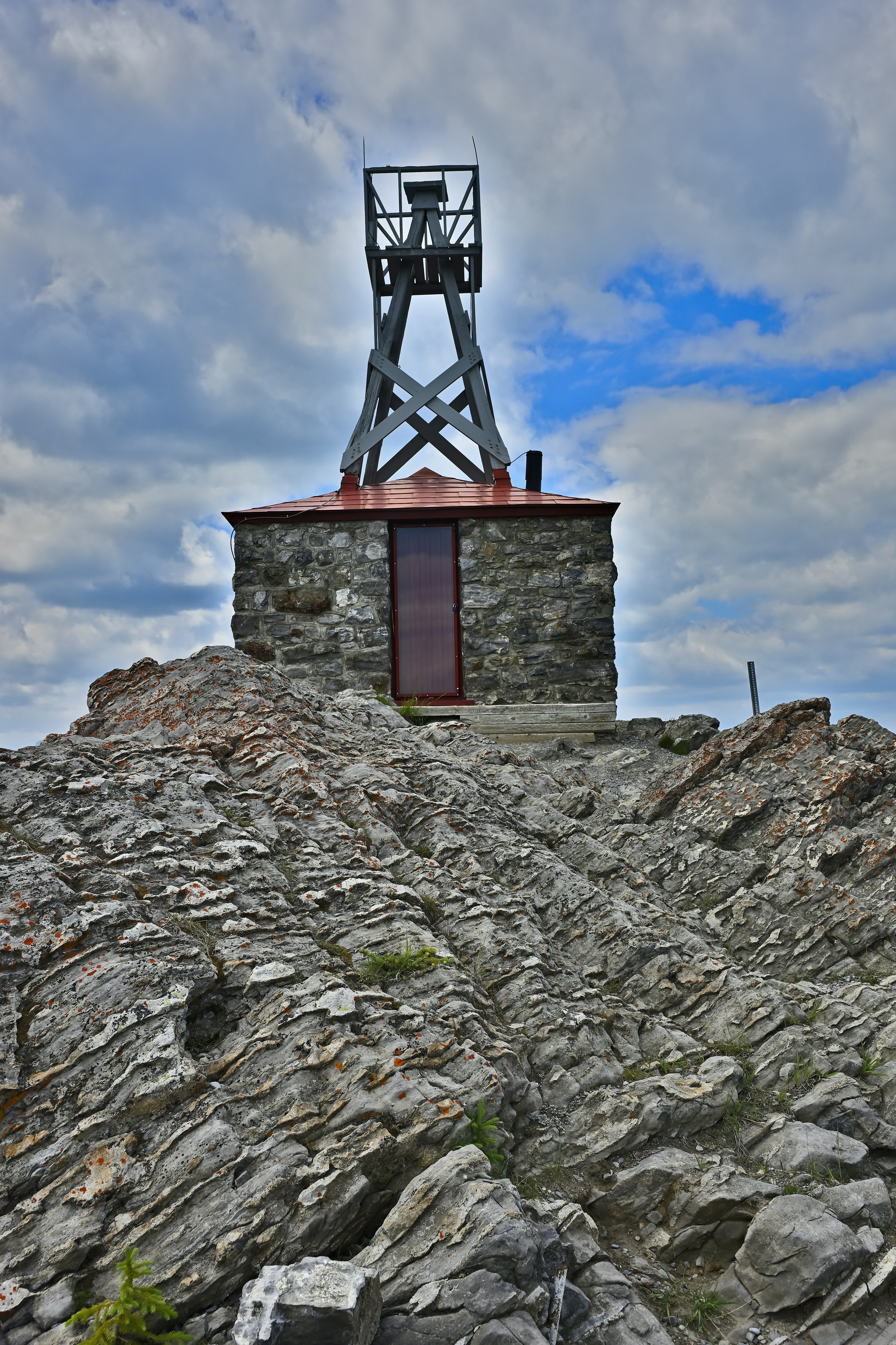 Stone Signal on the Ridge: A Weathered Lookout Tower Emerging from Jagged Rocks