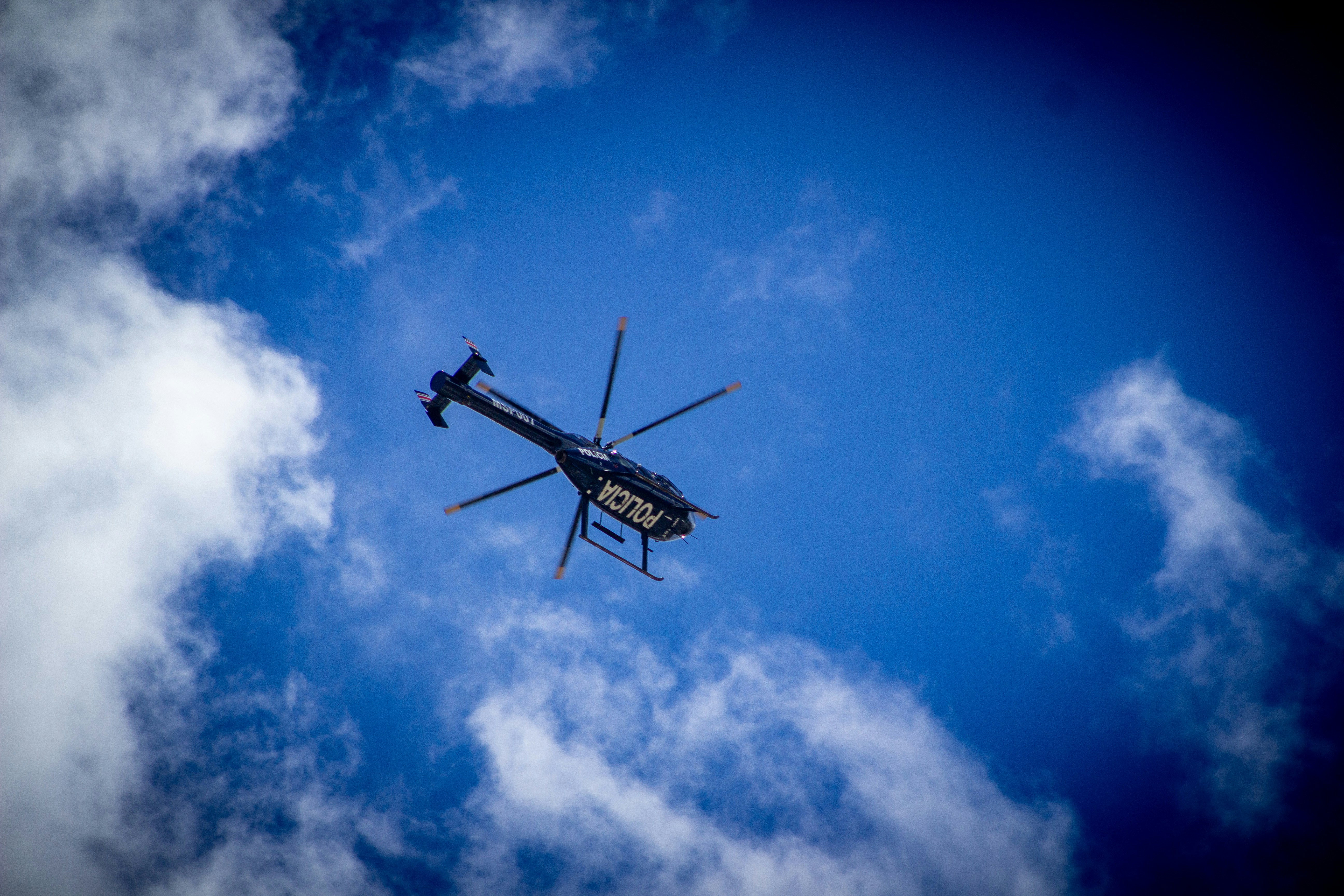 Skyward Dispatch: A Blackhawk in a Clear Afternoon Veil
