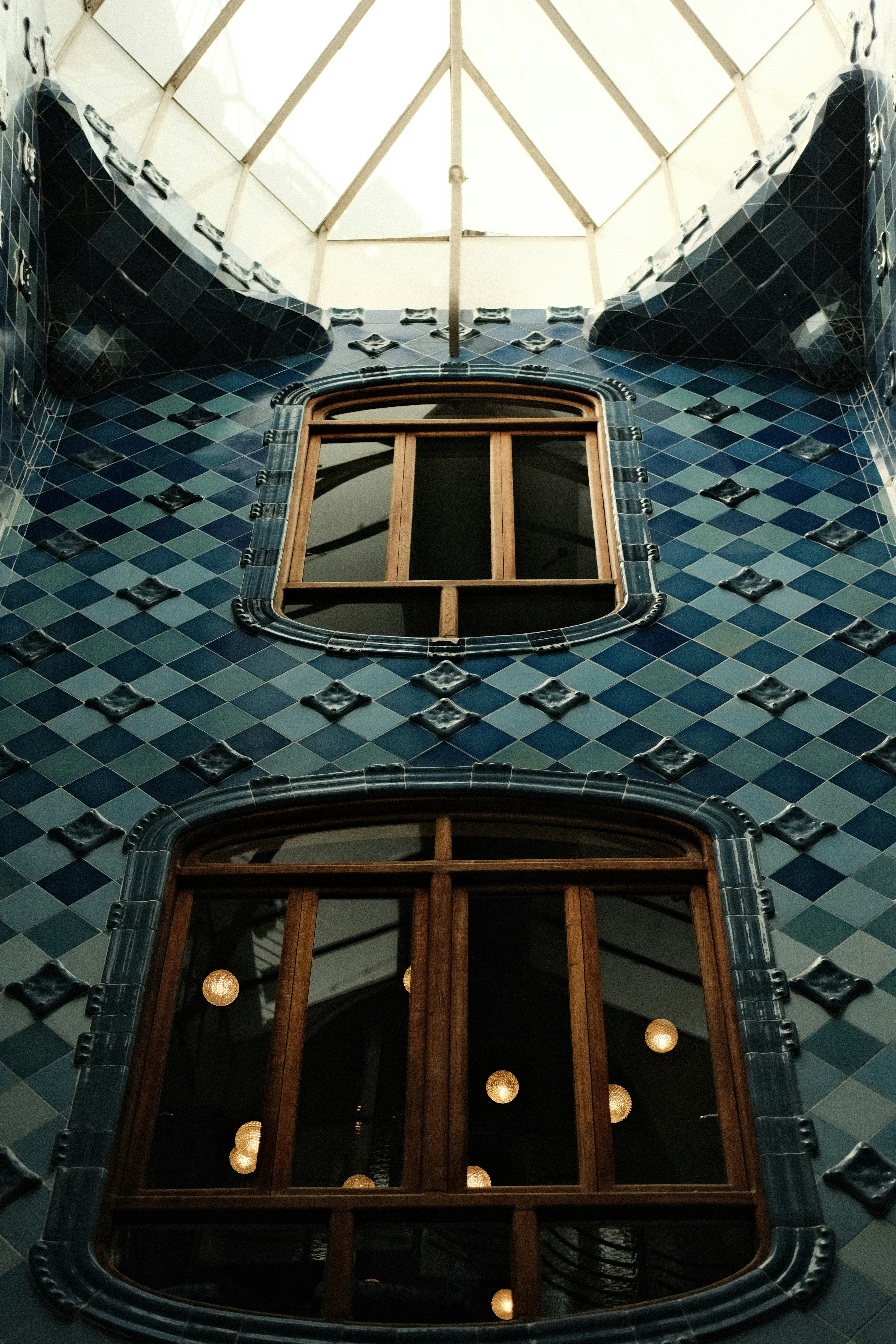 Blue Diamond Facade: A Wind-Swept Atrium Window with Artful Tilework