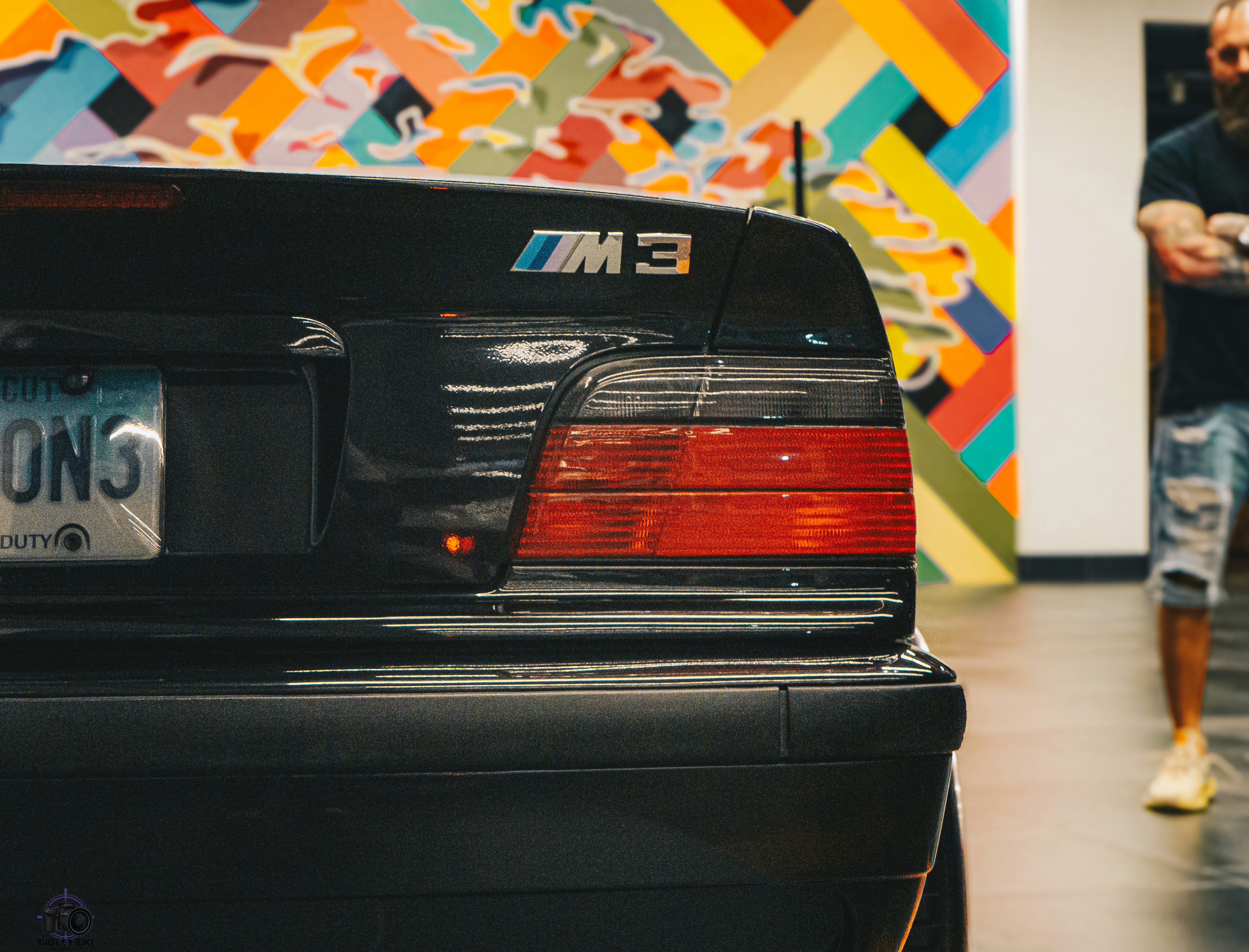 Rear Badge and Street-Style Portrait by a Painted Wall