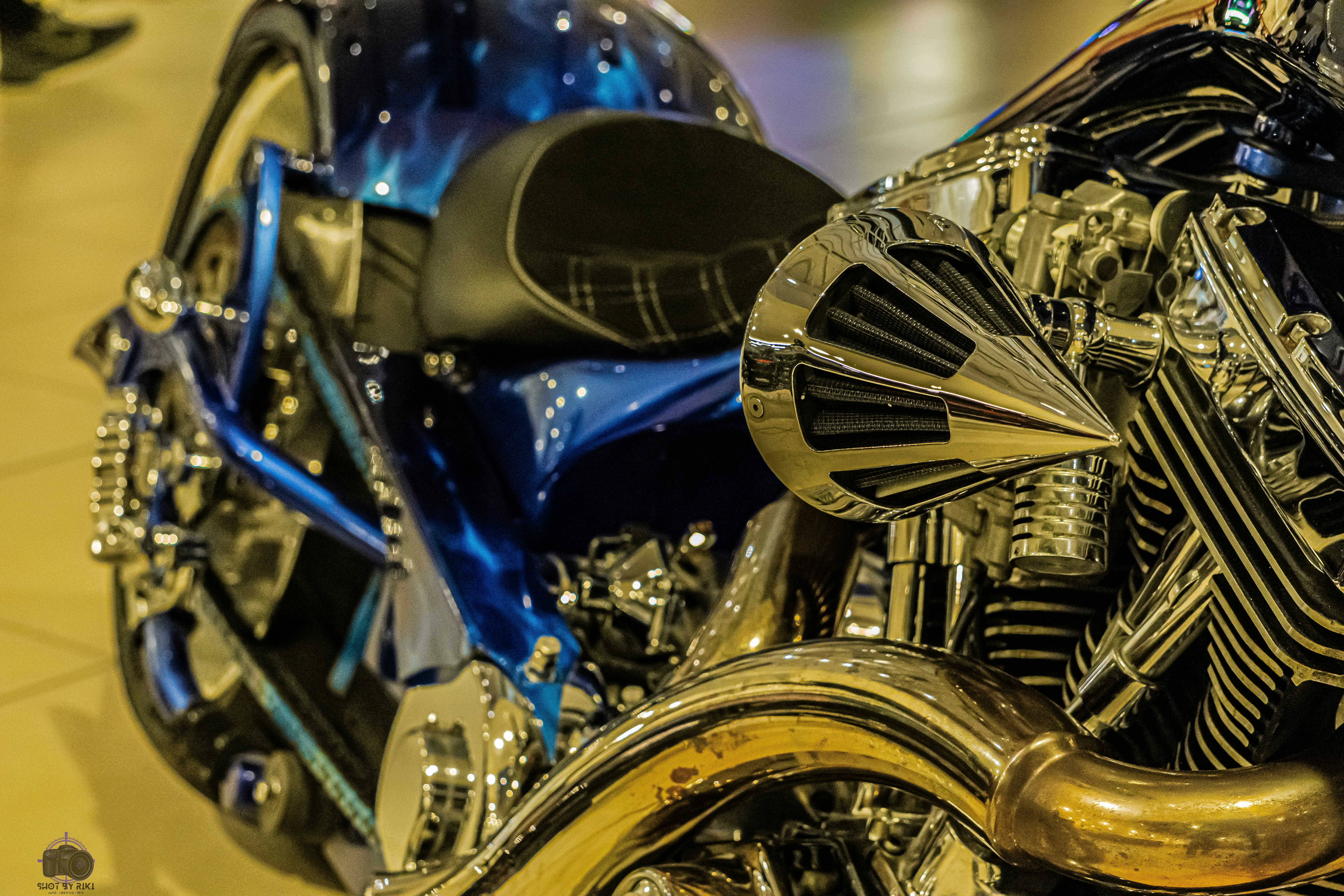 Blue Flame: a chrome-dusted cruiser in a dim showroom