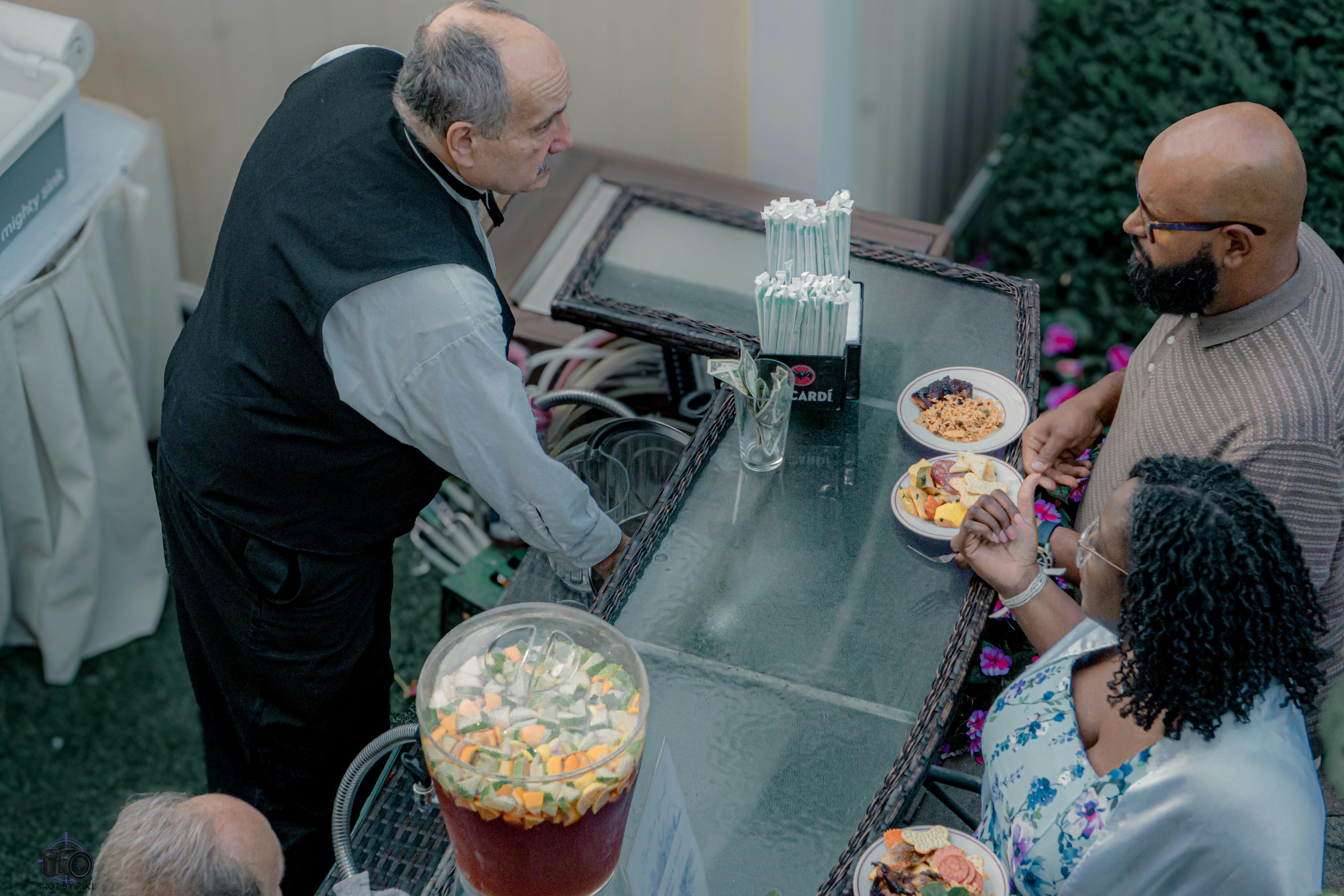 Dedicated bartender at work: a social moment around a backyard bar