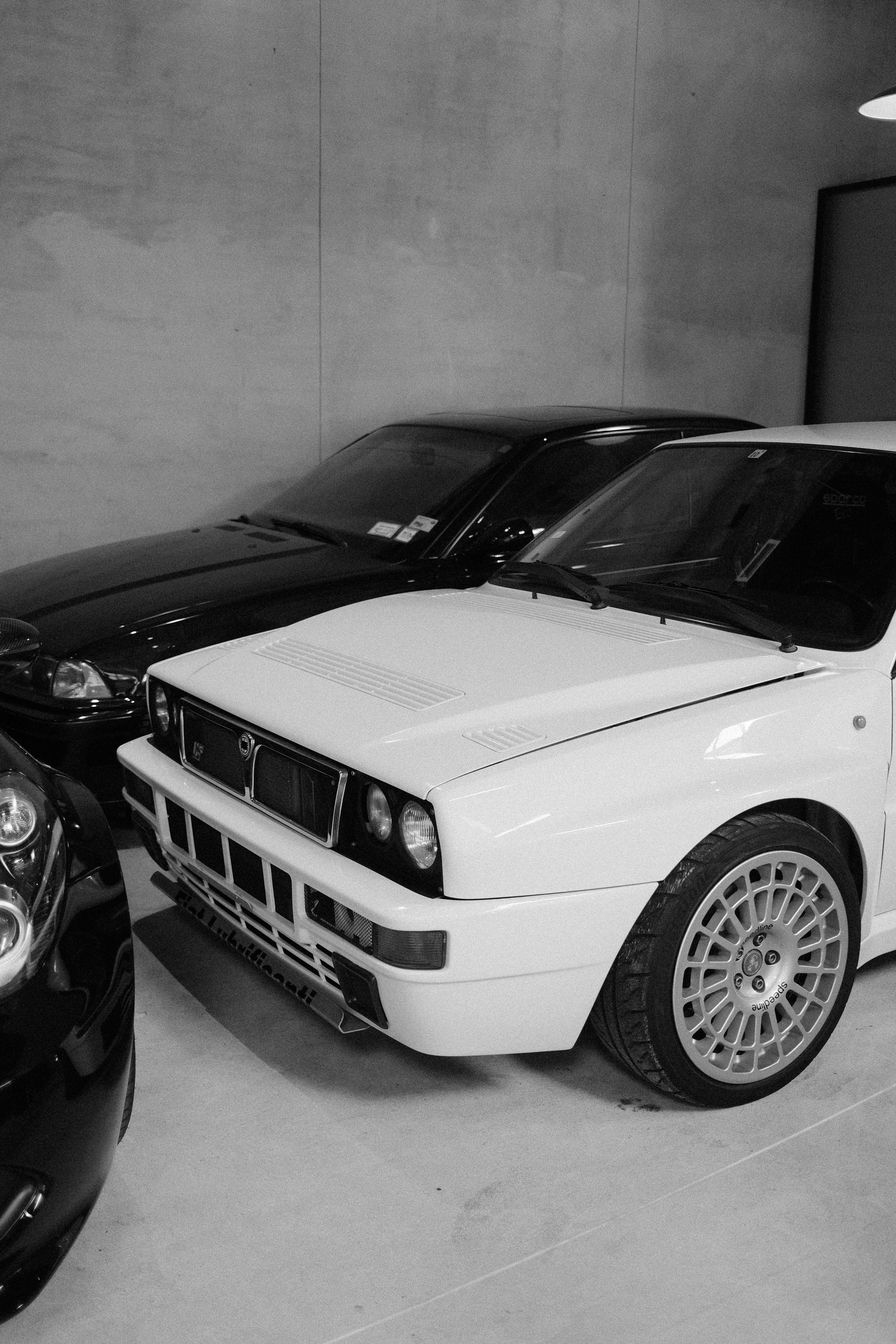 White Classic: A Glimpse of European Steel in a Concrete Garage